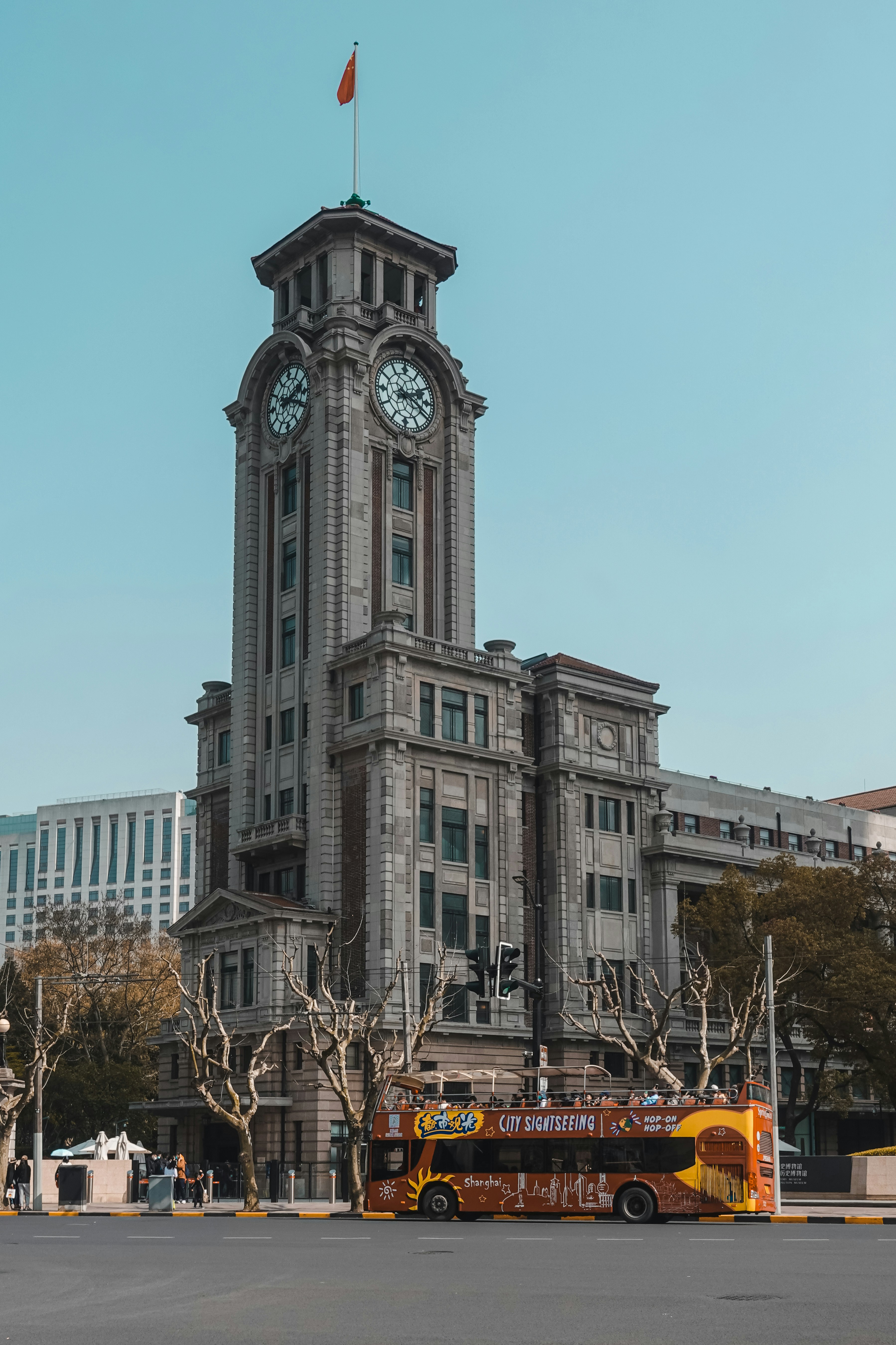 Clocktower Over City Bus: Urban Heritage under a Clear Sky