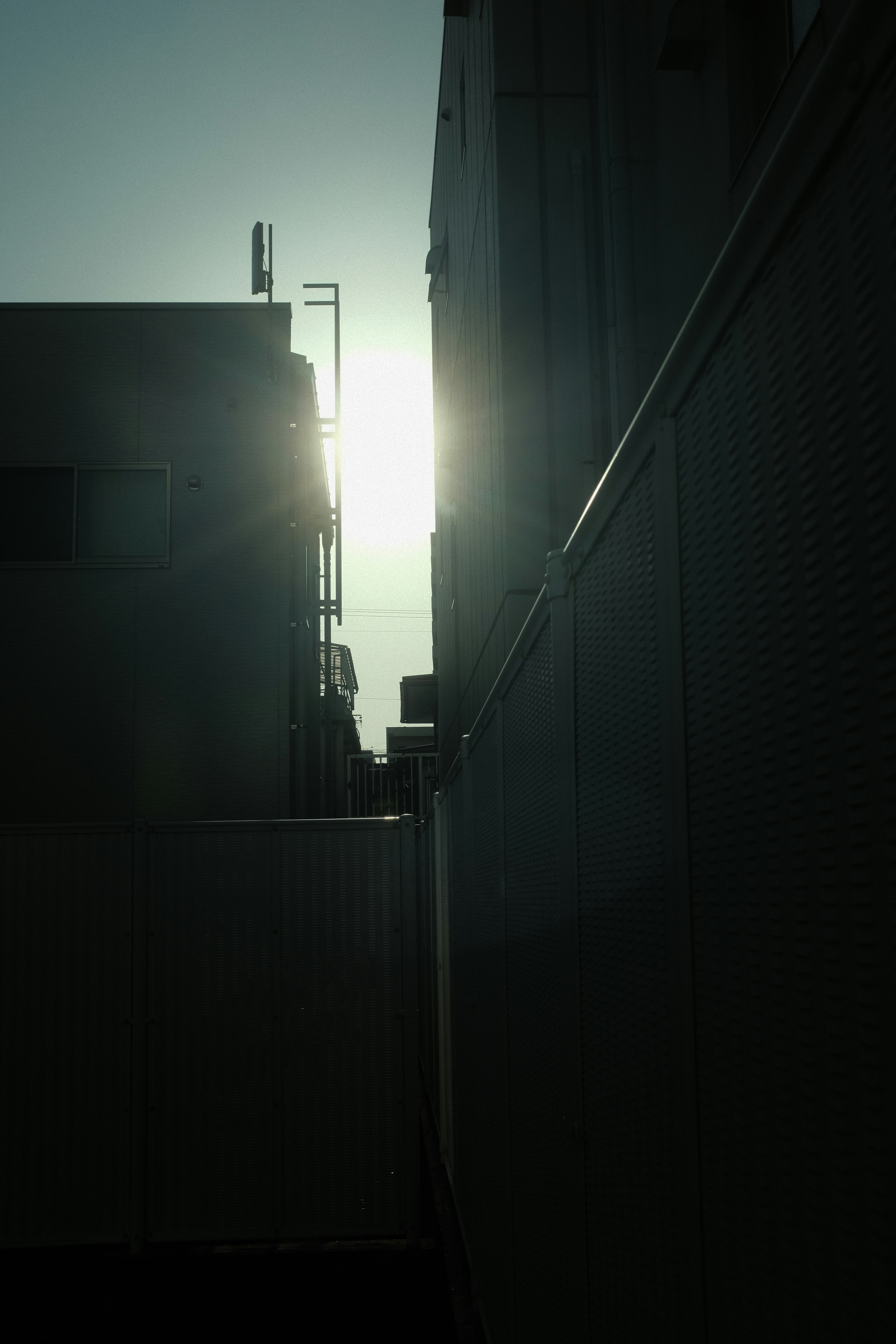 Sunburst Corridor: Backlit Alley Between Tall Urban Walls