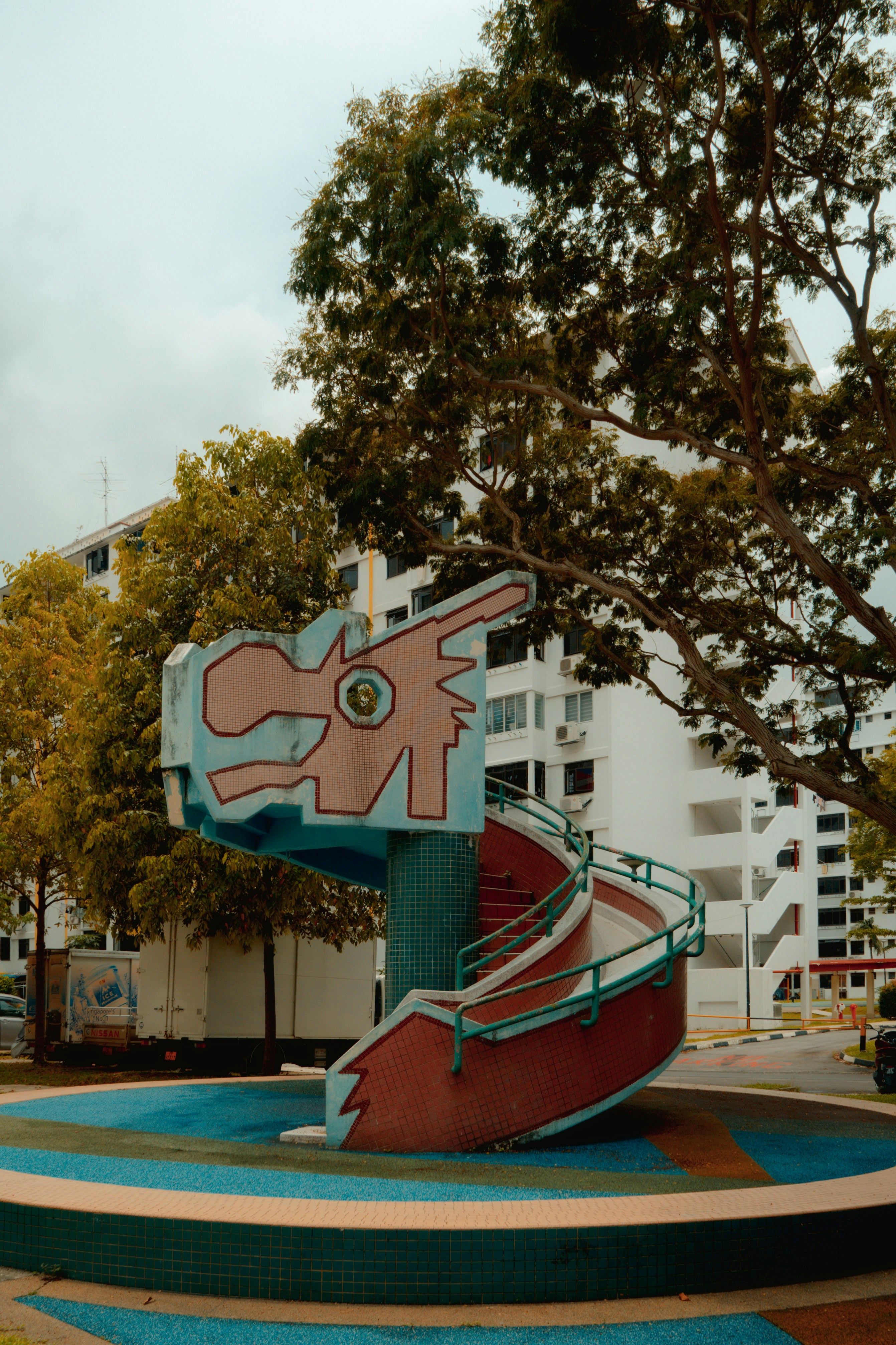 Pink Sentinel Over a Teal Spiral: Public Art in a Sunlit Residential Square
