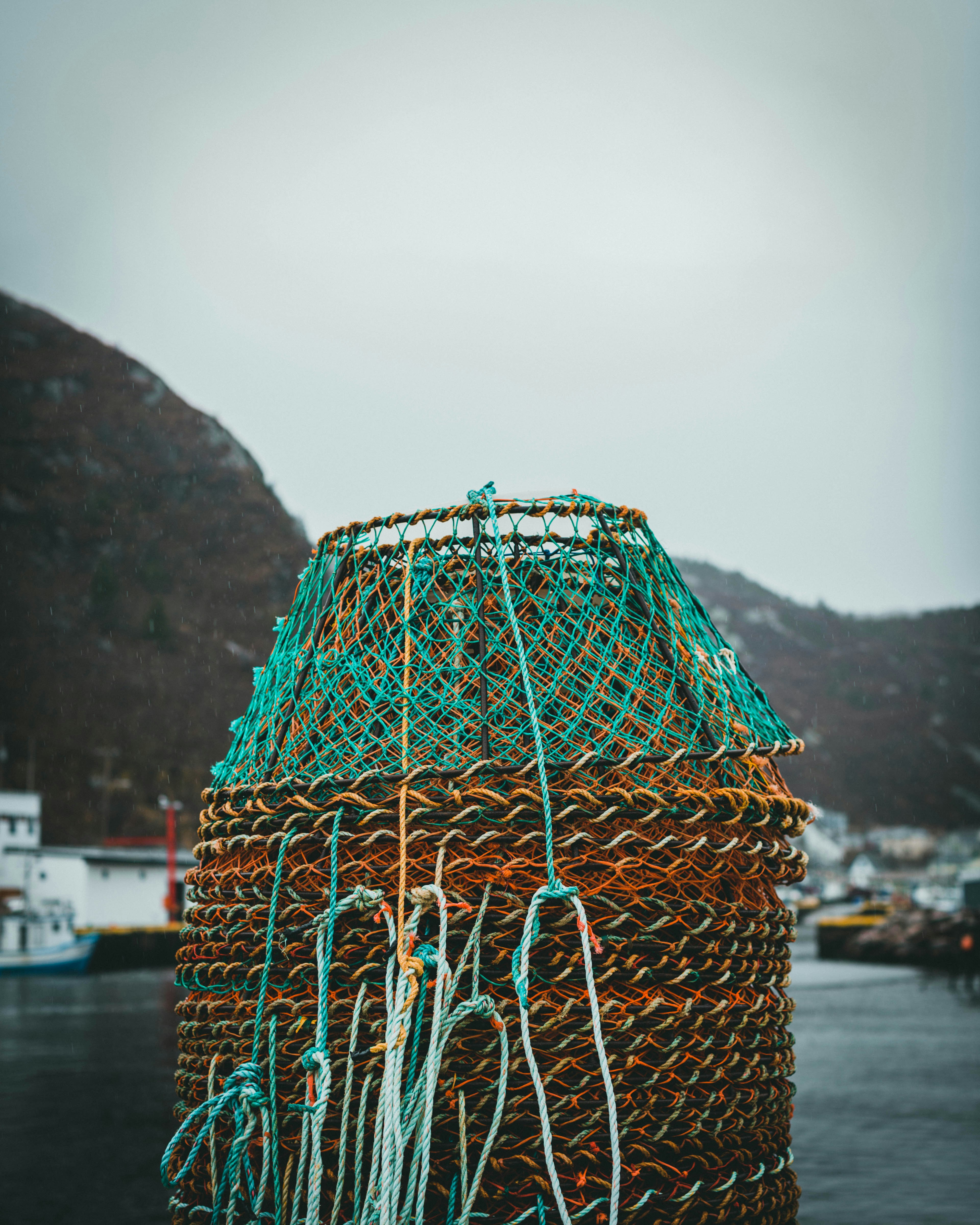 Teal-Net Harbor Pots: Stacked Woven Traps by the Quay