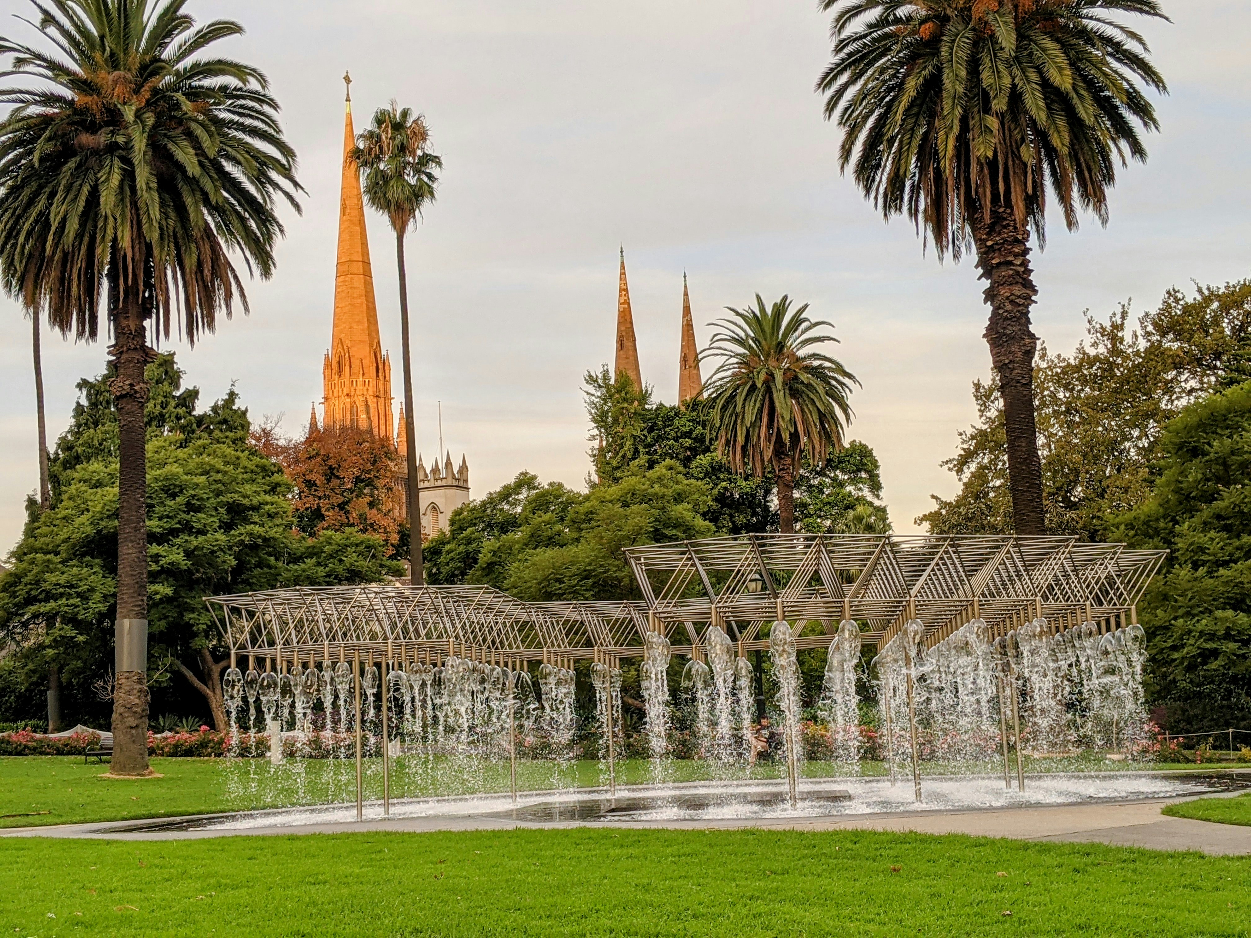 Water Arches and Palm Canopies: A Park Fountain Before Gothic Spires