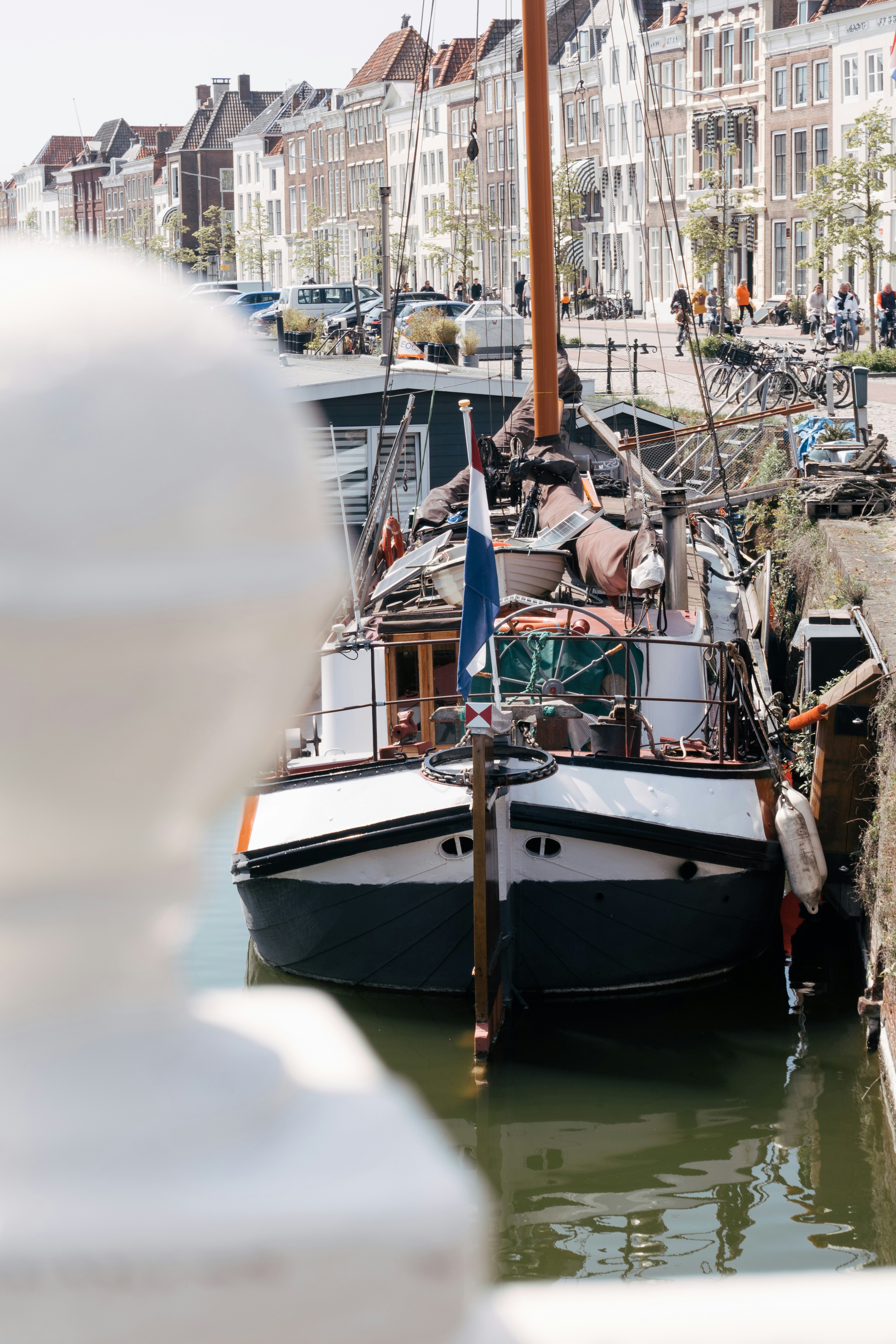 Mooring Dream: A Canal Scene Framed by Distant Town Facades