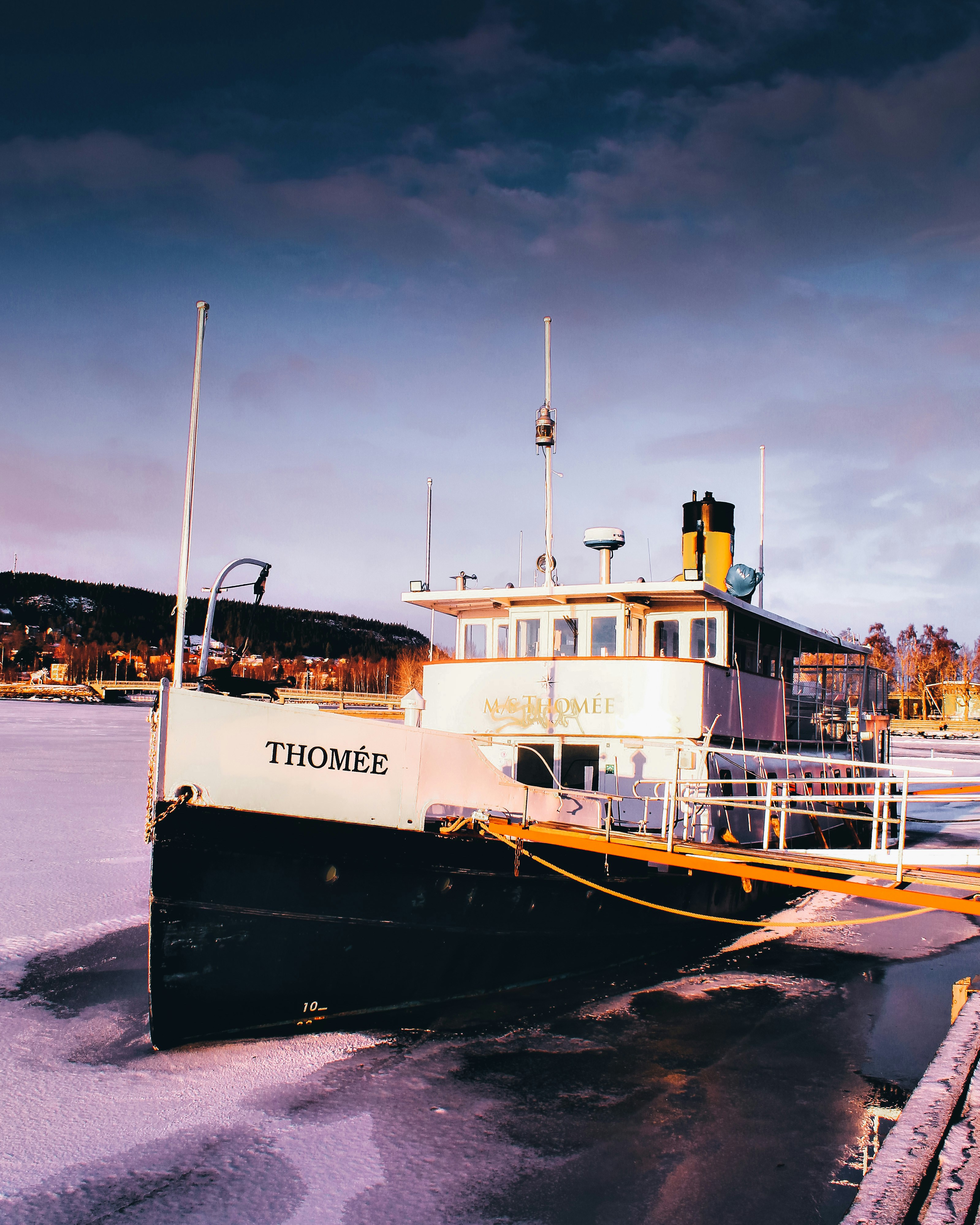 THOMÉE Steamboat Gracing a Pink Frost on the Frozen Lake at Dusk