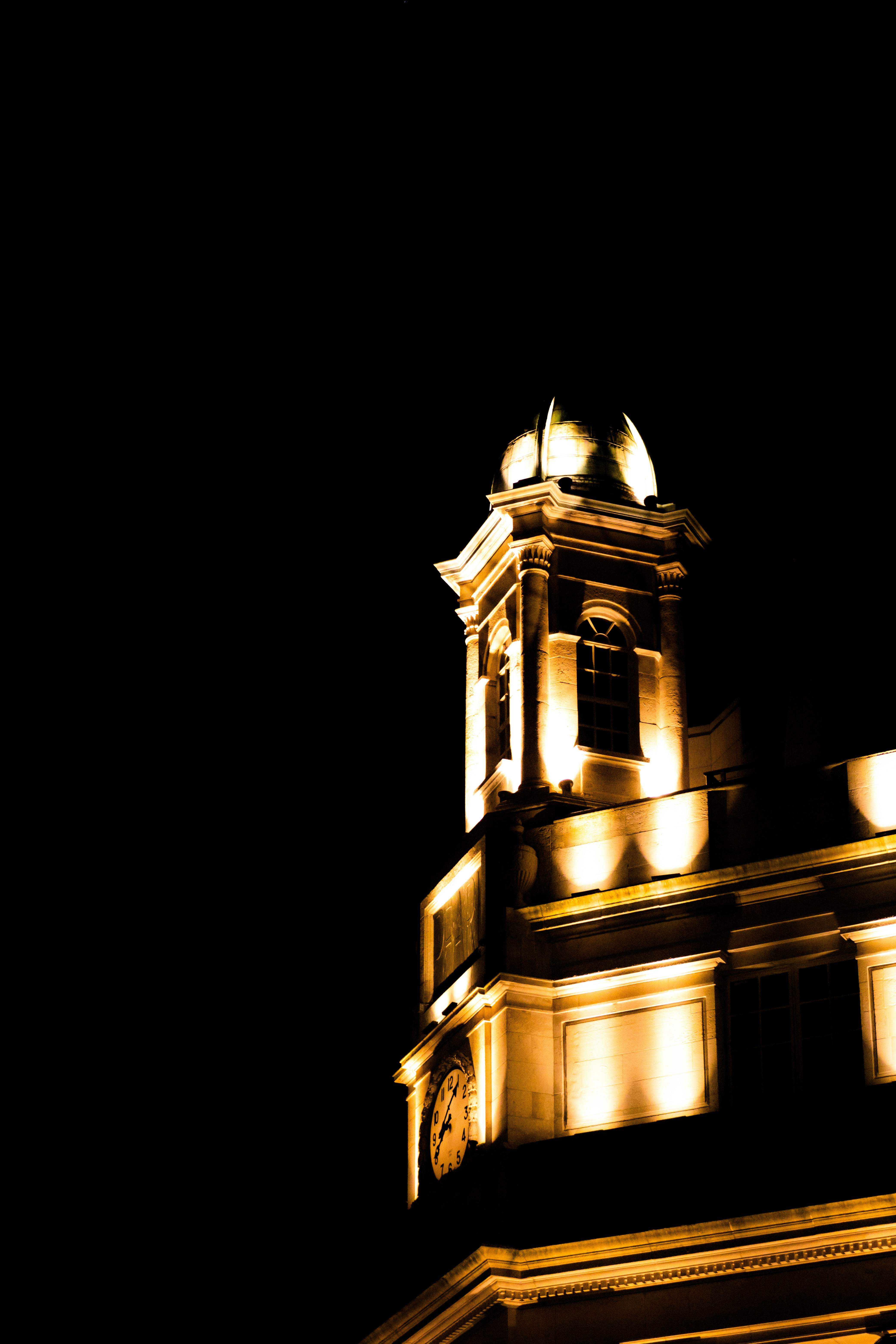 Amber-lit Clocktower: Night Beacon on a Dark Canvas