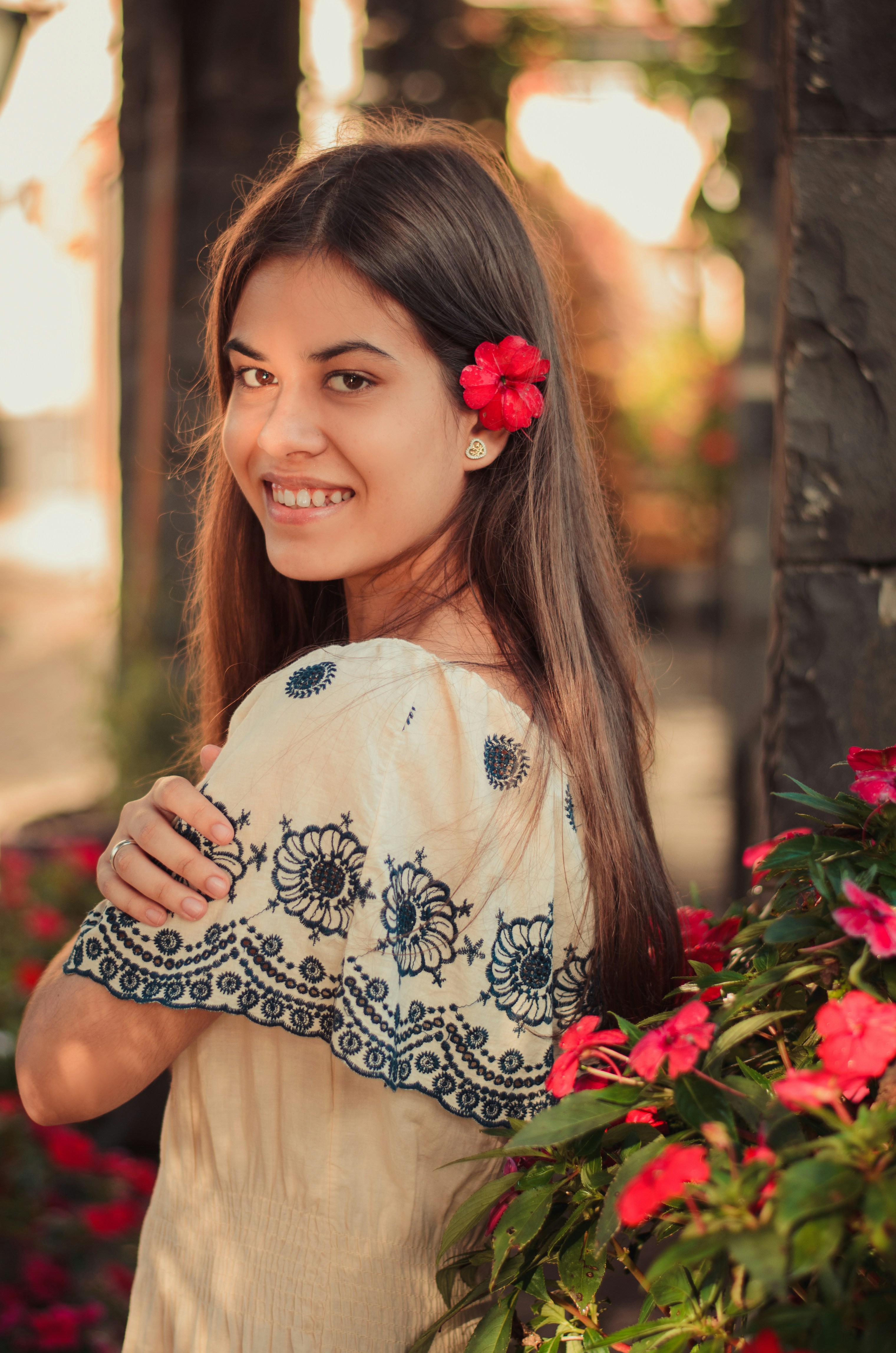 Crimson Blooms Frame a Warm-Hearted Smile