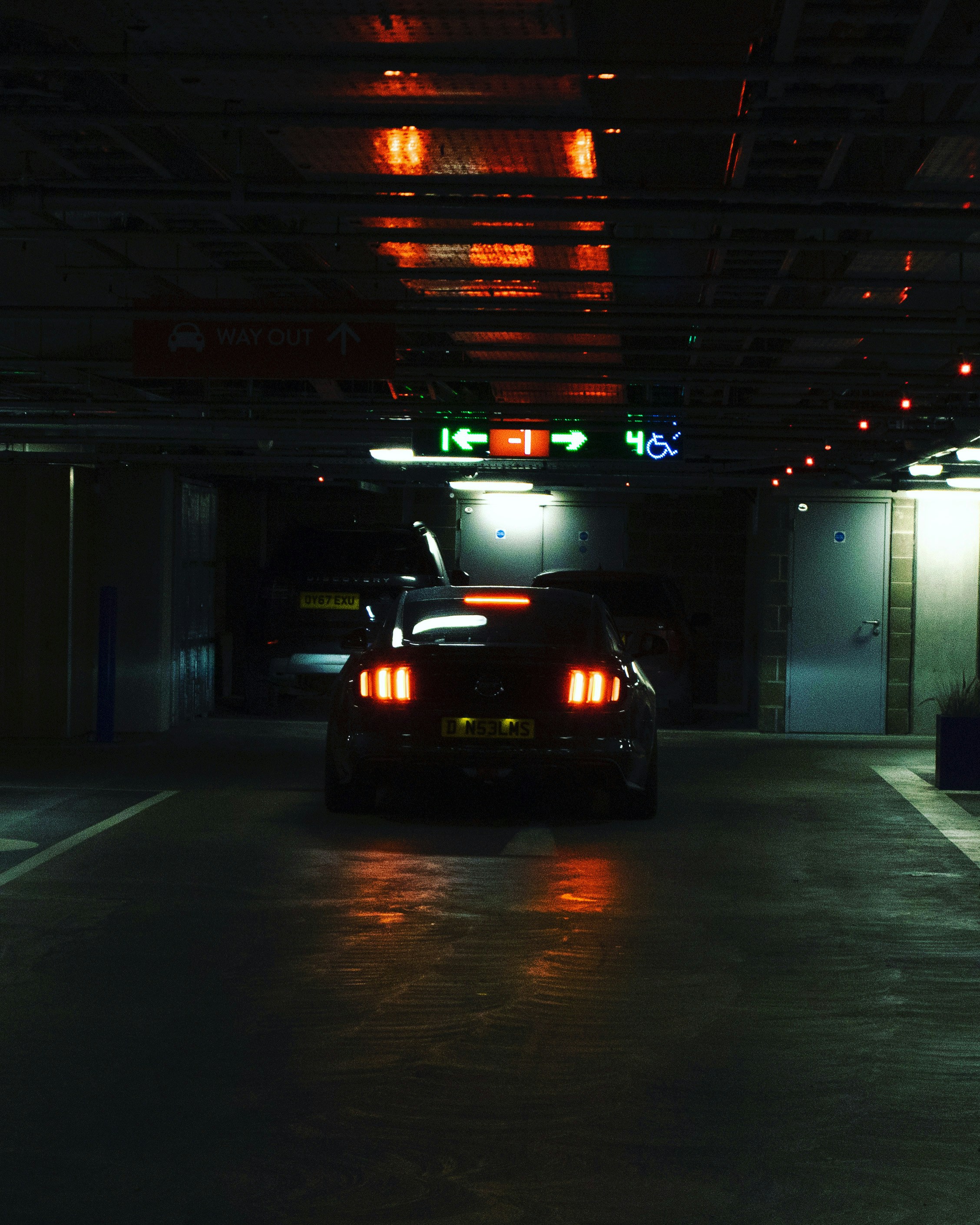 Midnight Mustang: Tail Lights in a Dim Parking Garage