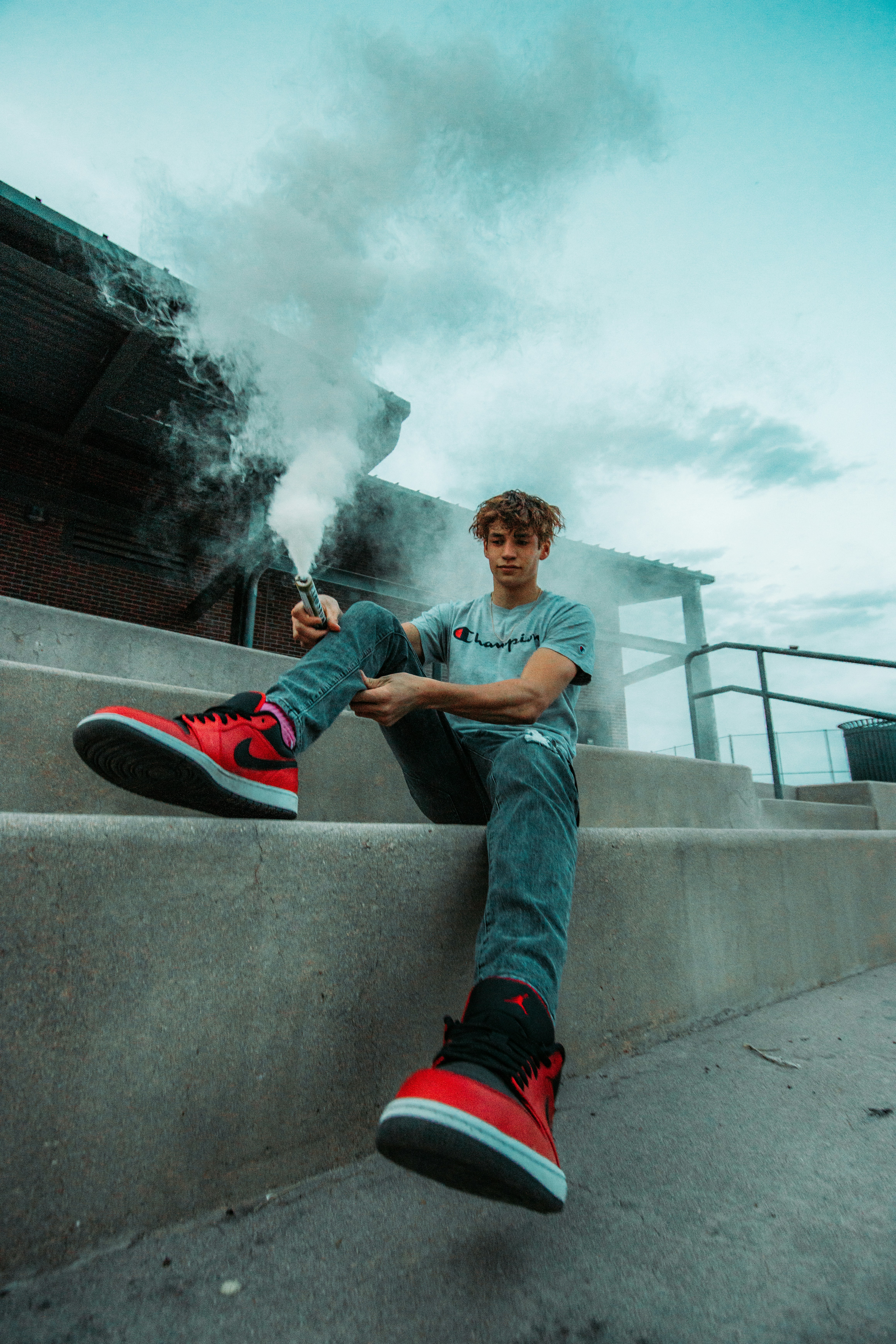 Smoke and Sneakers: A Youthful Moment on the Concrete Steps