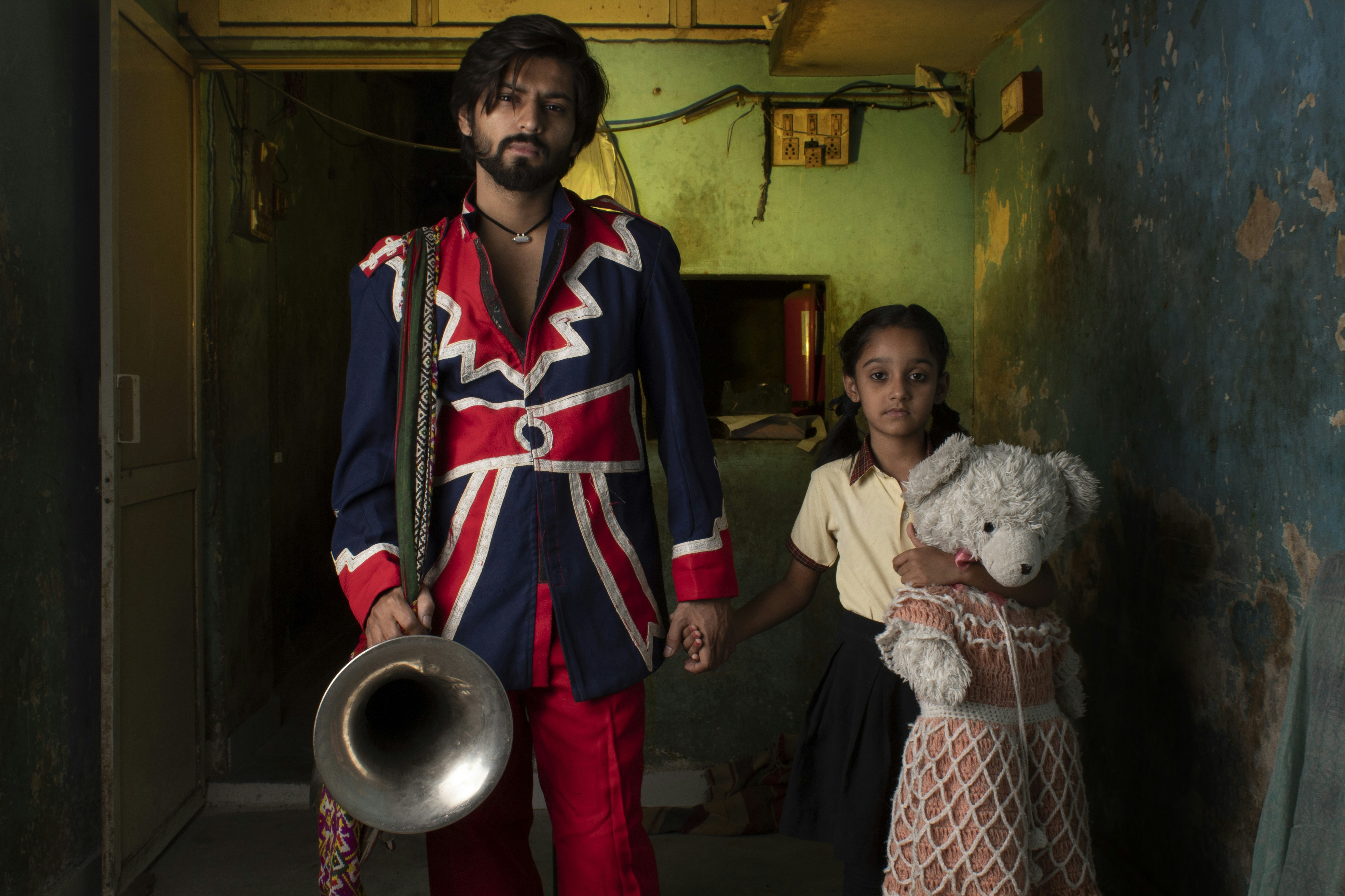 Man in black and red zip up jacket holding brass trumpet photo – Free ...