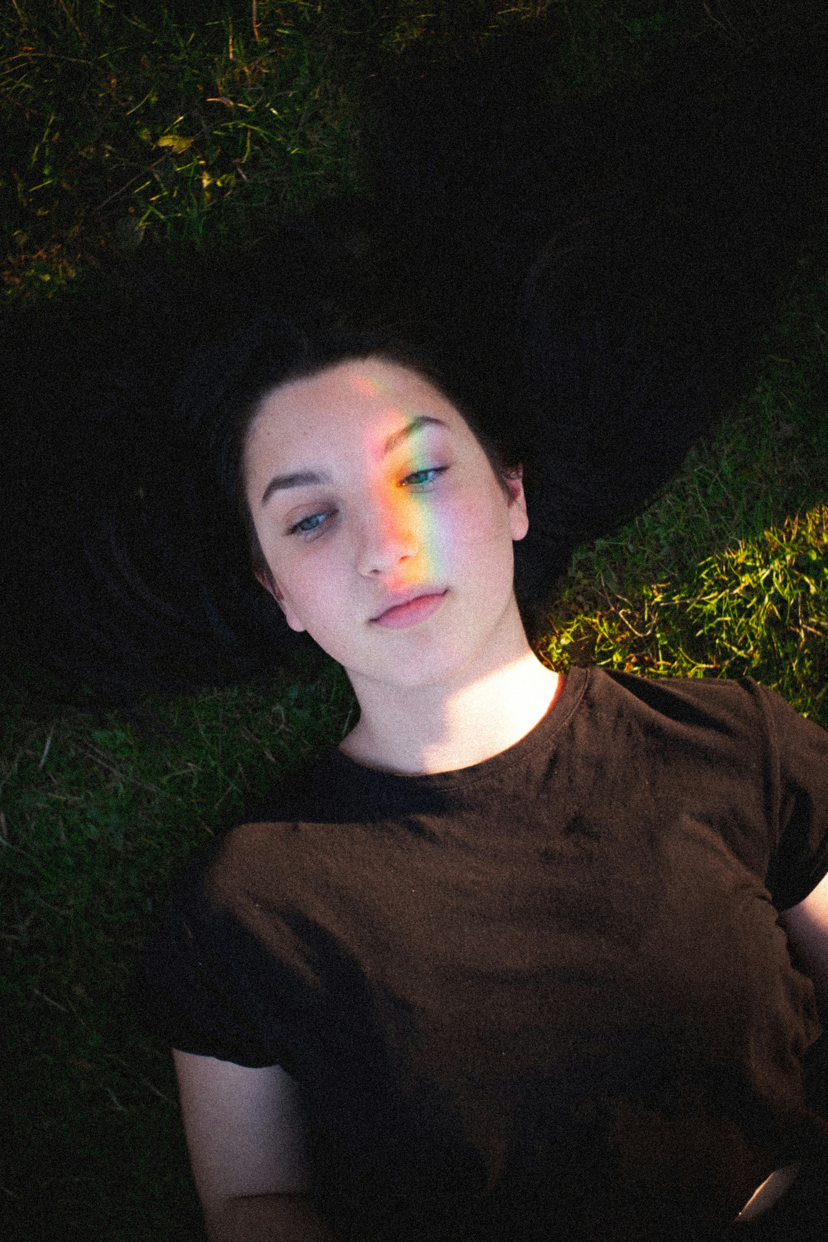 Woman in black crew neck shirt lying on green grass photo – Free Girl ...