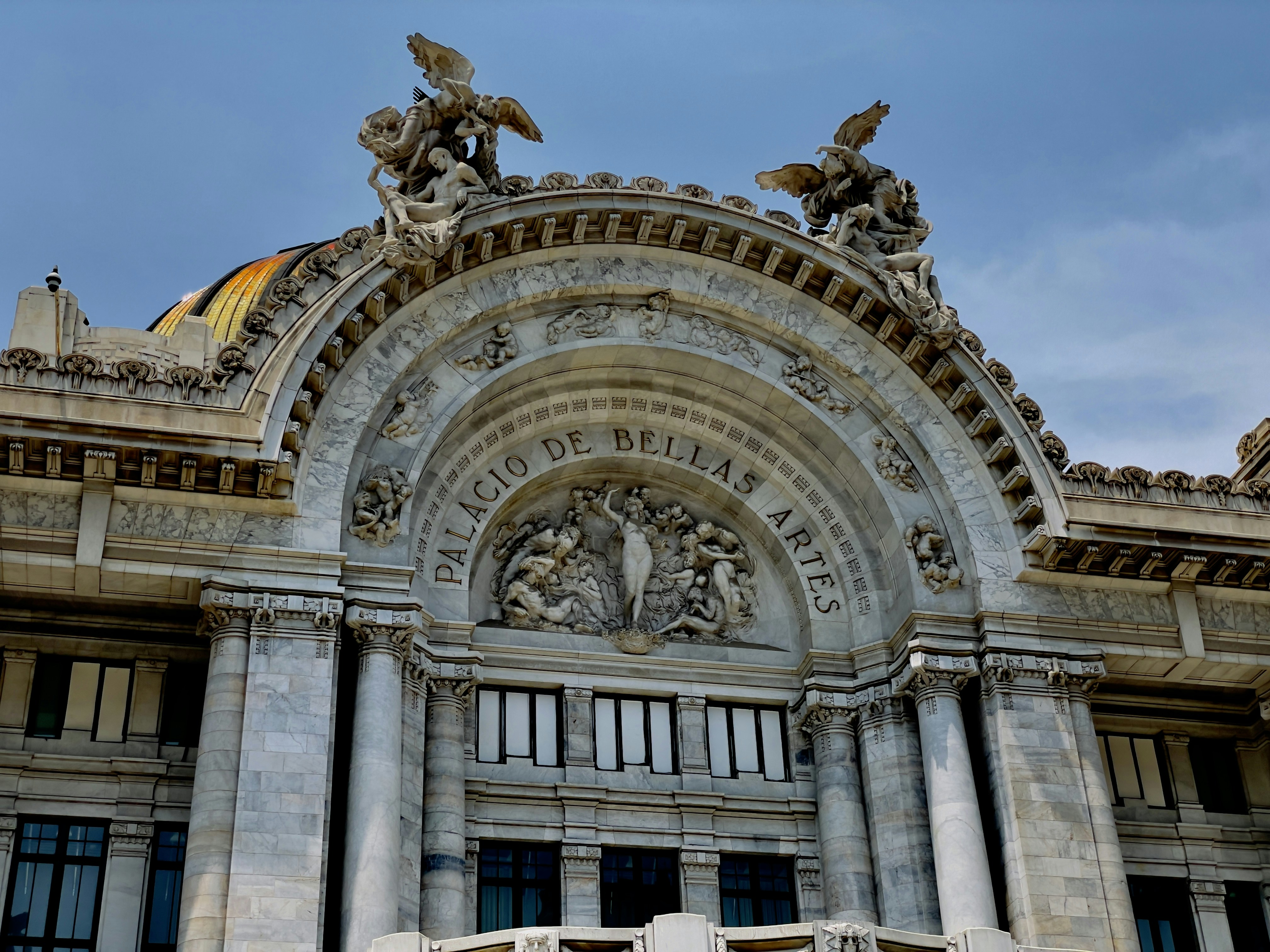 Marble Guardians Over the Bellas Artes Archway