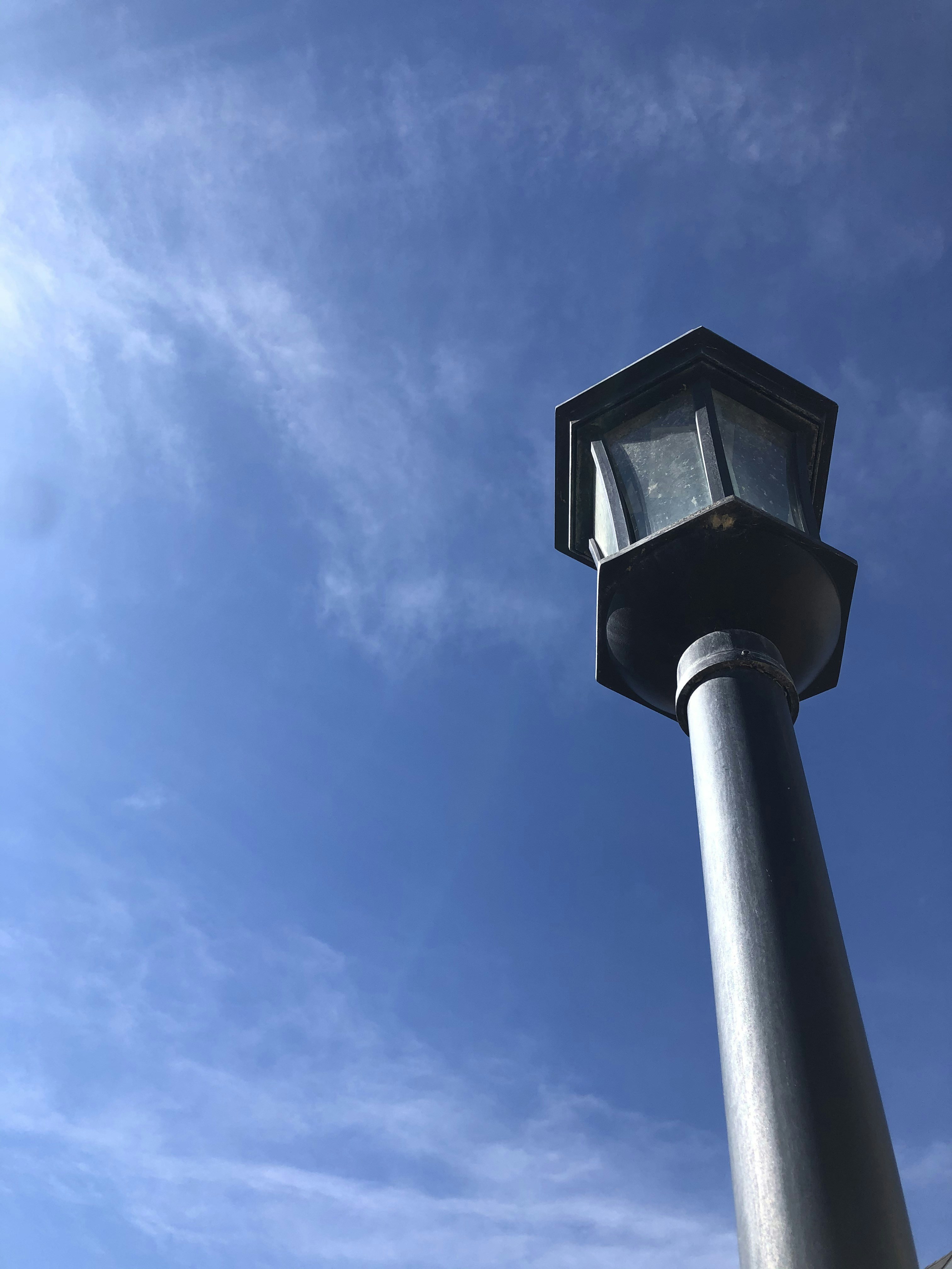 Industrial Lantern Reaches Toward a Painterly Blue Sky