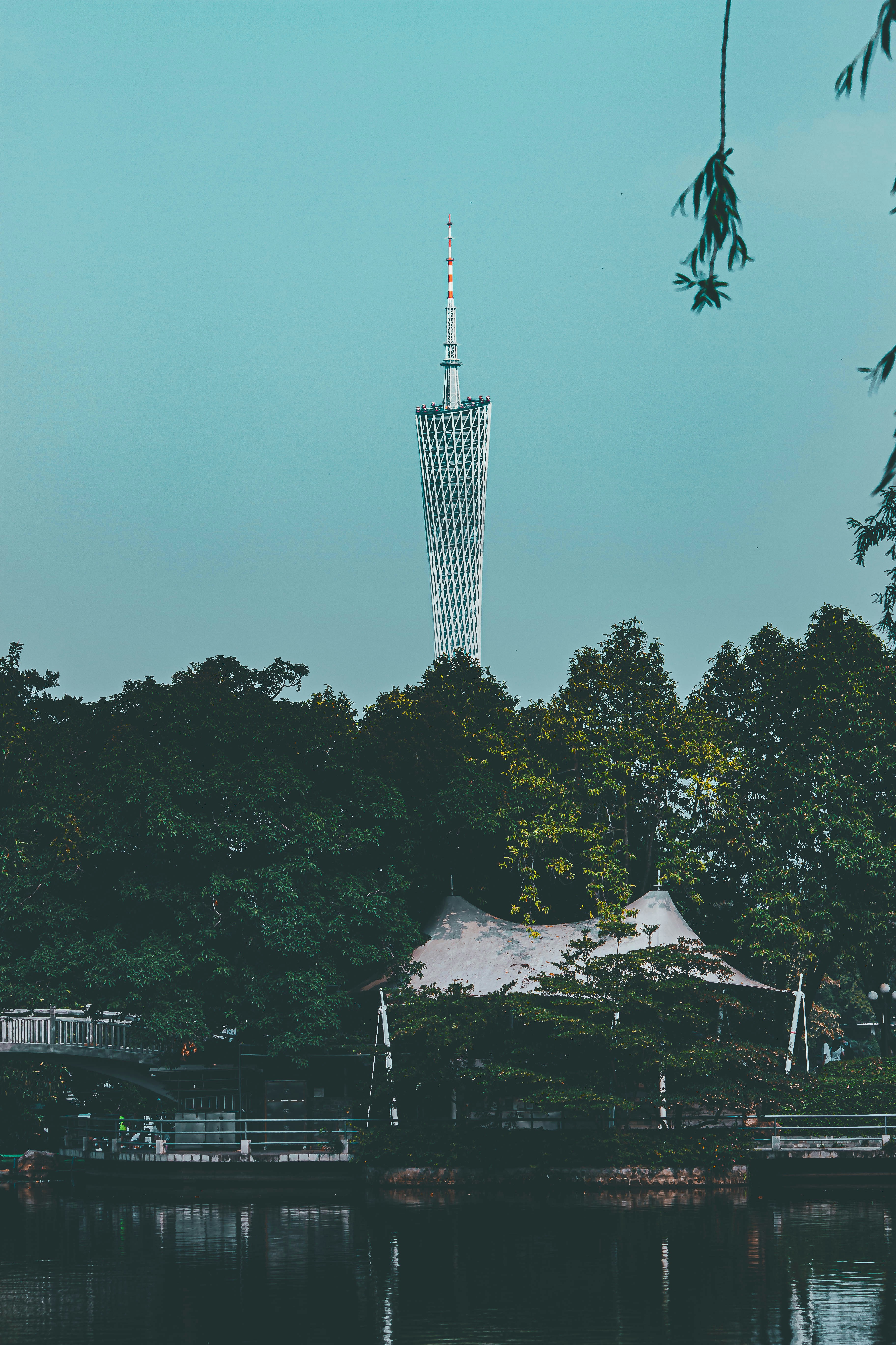 Teal Sky, Lattice Spire: Riverside Park Framing a Tower