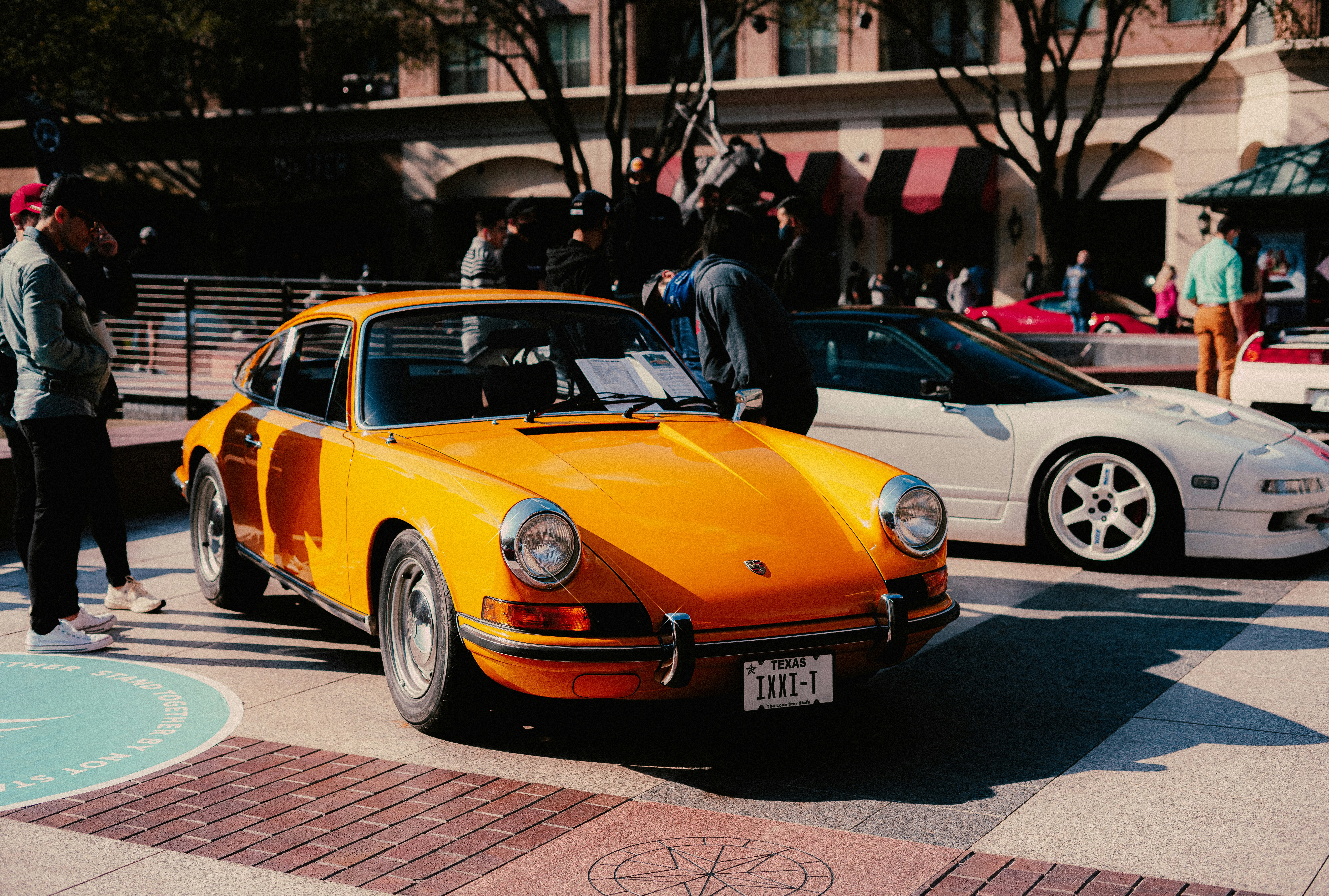 Amber Porsche Rendezvous in a Sunlit Car Show