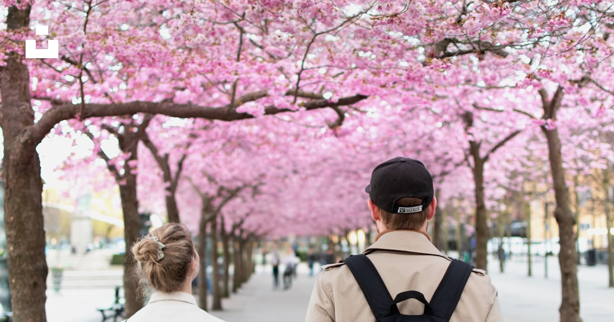 Man In Black Knit Cap And White Long Sleeve Shirt Standing Beside Woman