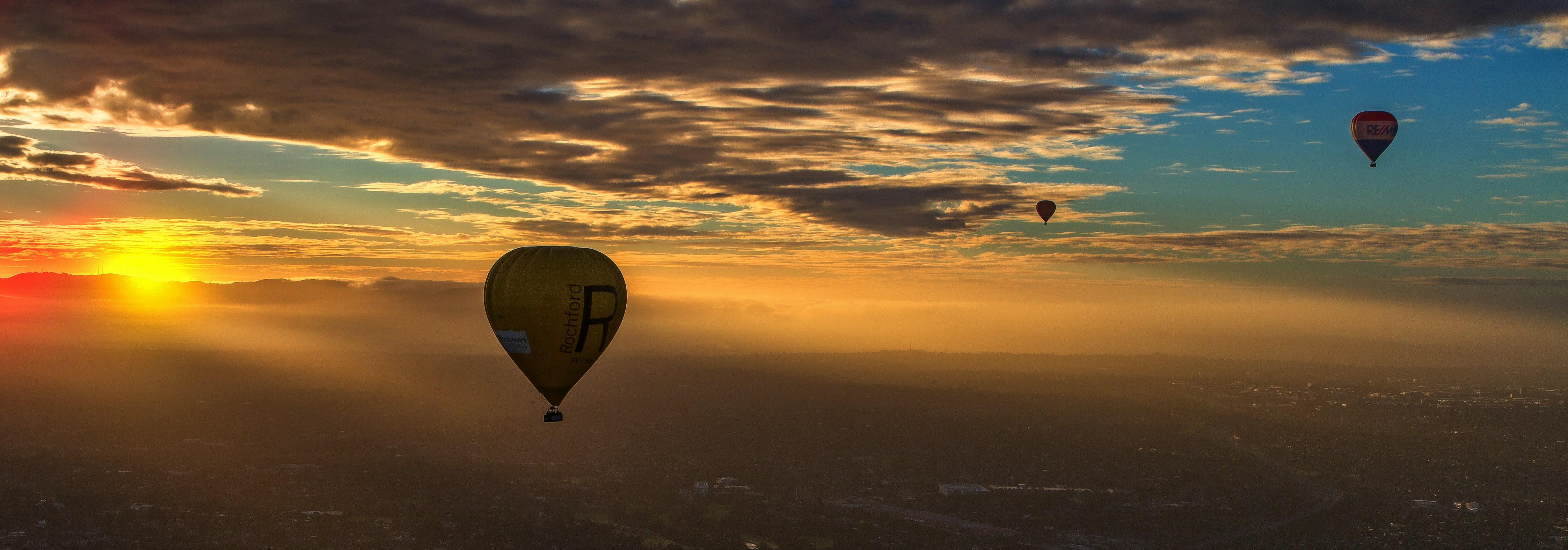 Sun-kissed Soufflé: Balloons Drifting over a Dusk-Willed Horizon