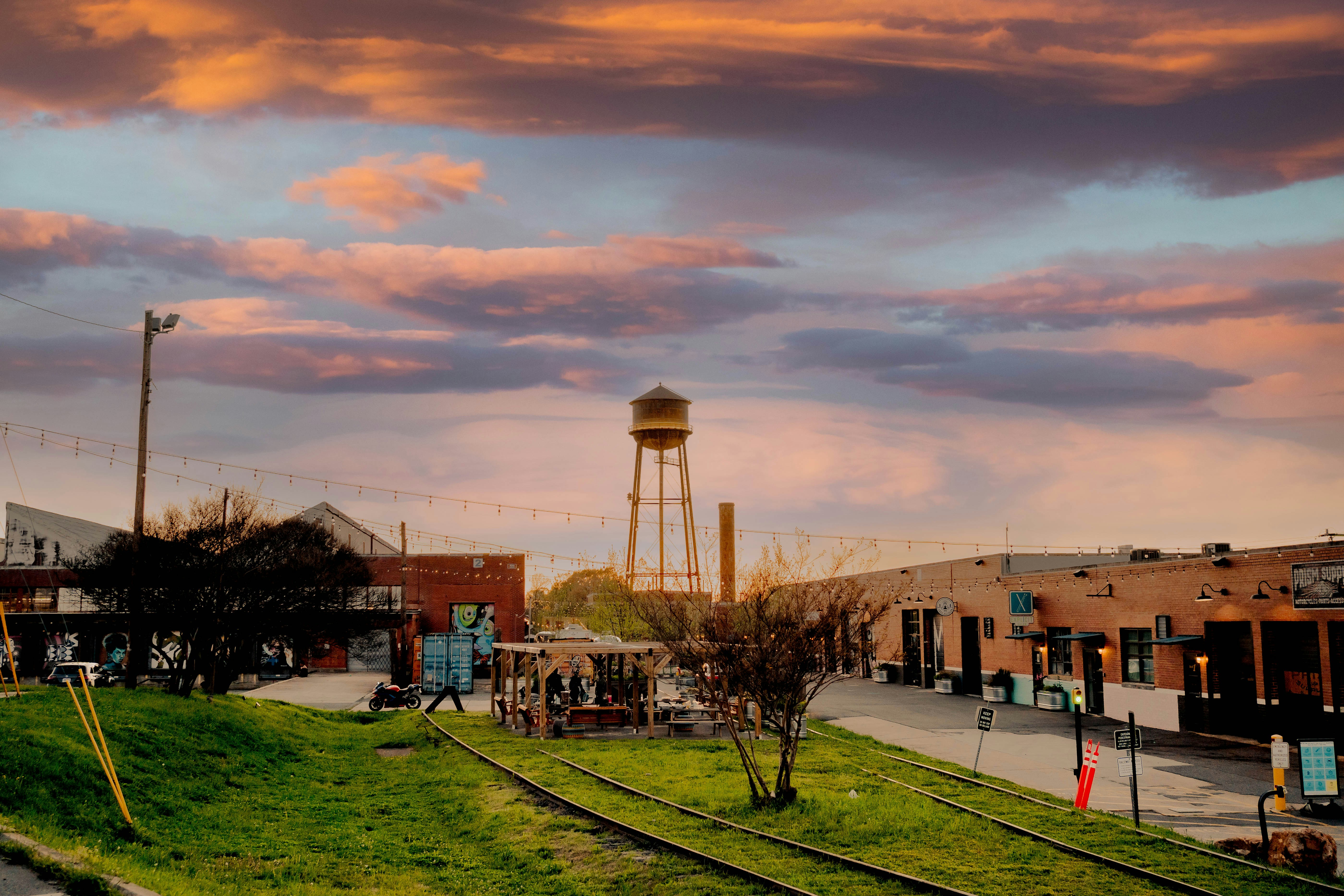 Camp North End in Charlotte has never looked better than in this sky and the prettiest sunset. | white and brown concrete building under cloudy sky during daytime