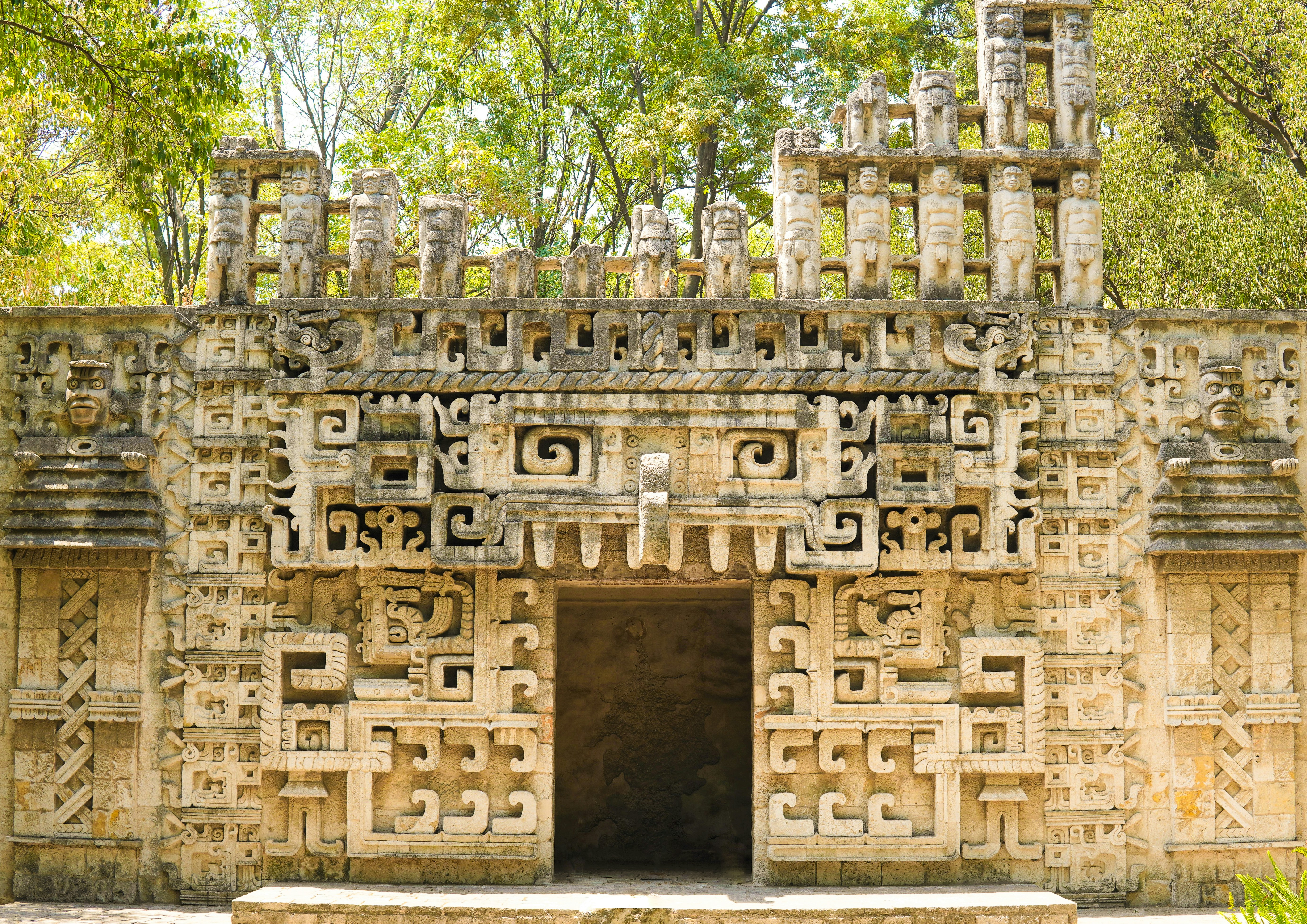 A stone structure with carvings on the front of it photo – Free ...
