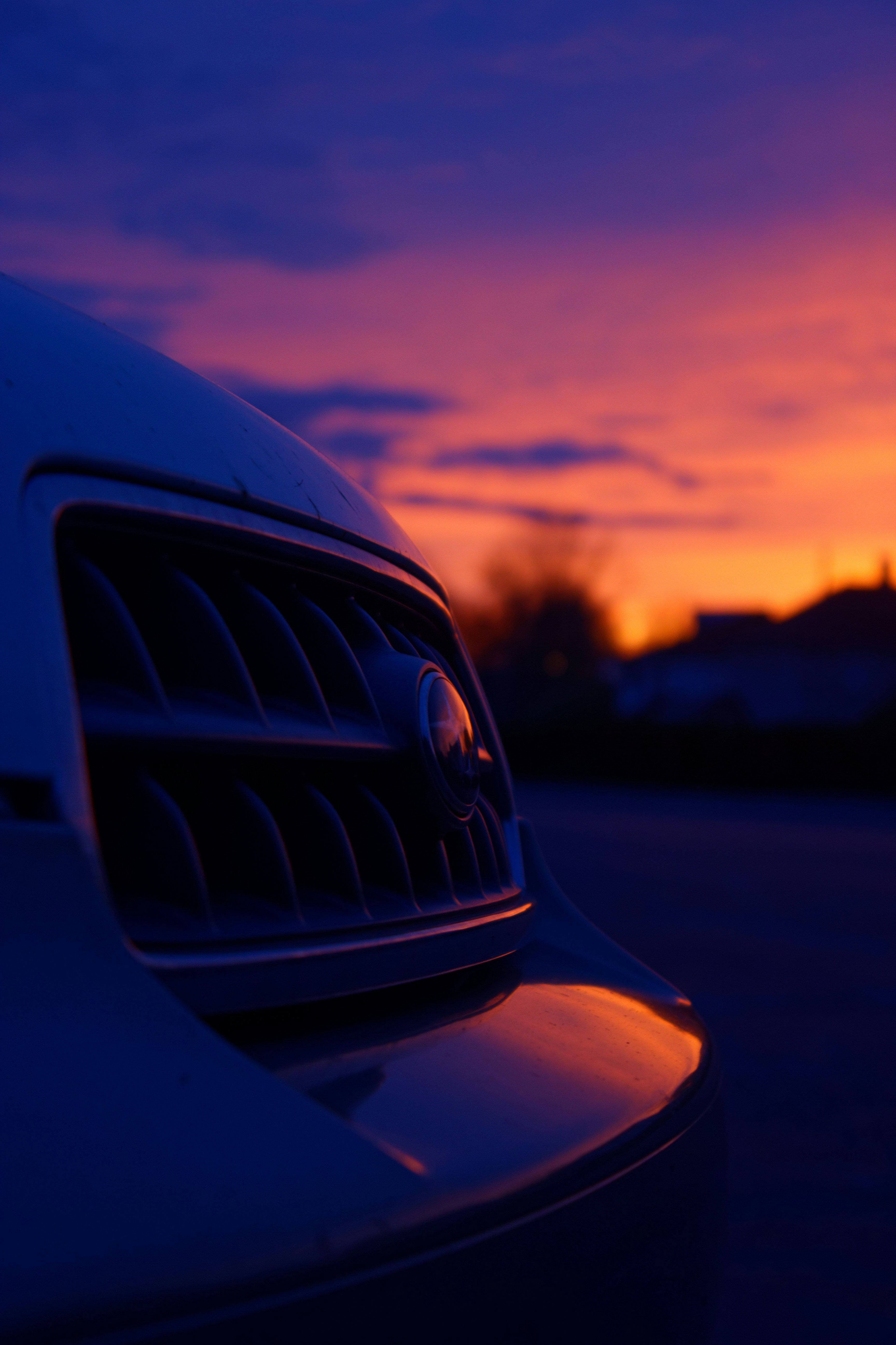 Front Grille at Sunset: A Car's Silhouette in Violet Hour