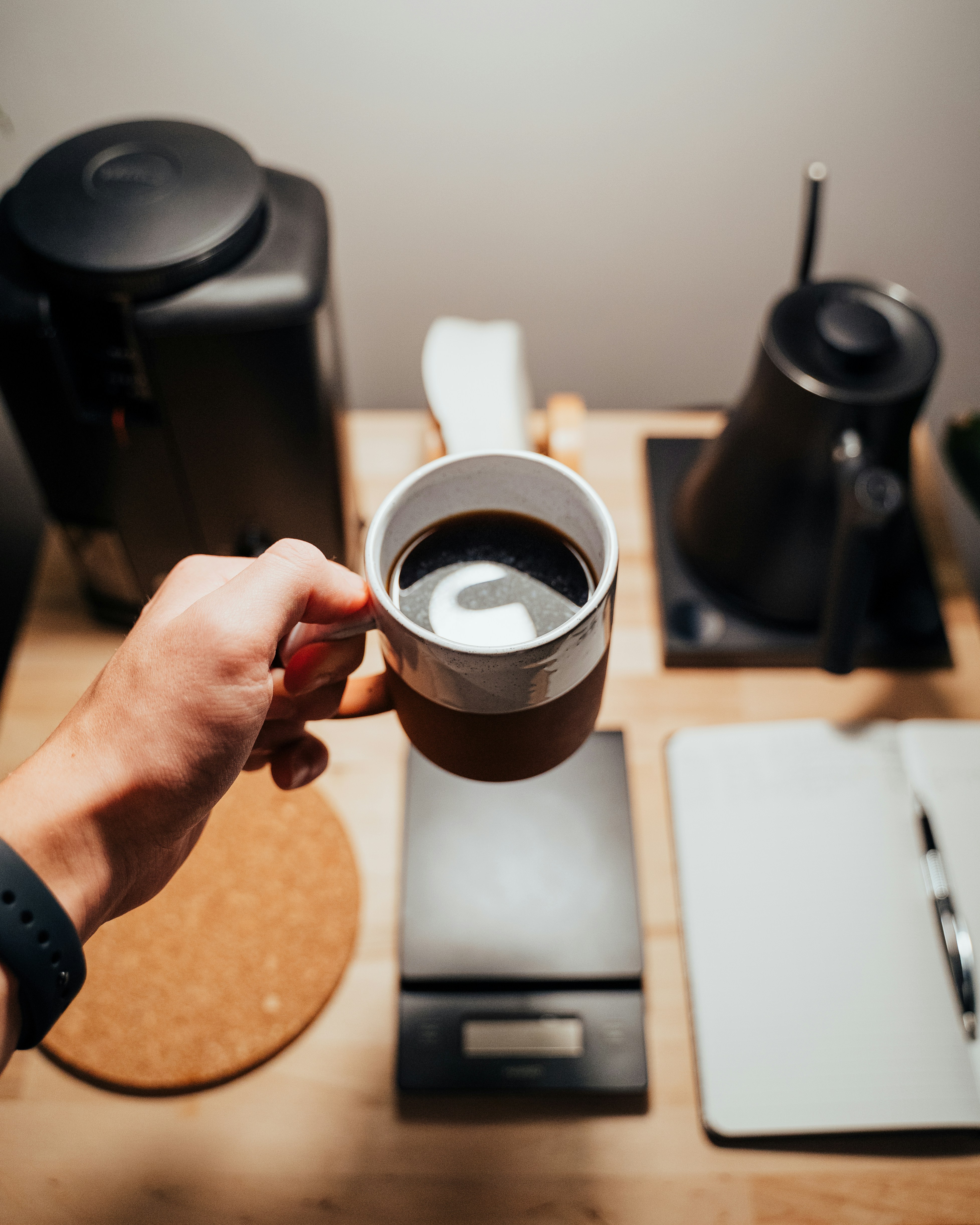 Hand-Held Espresso Moment Amid Pro Brew Gear