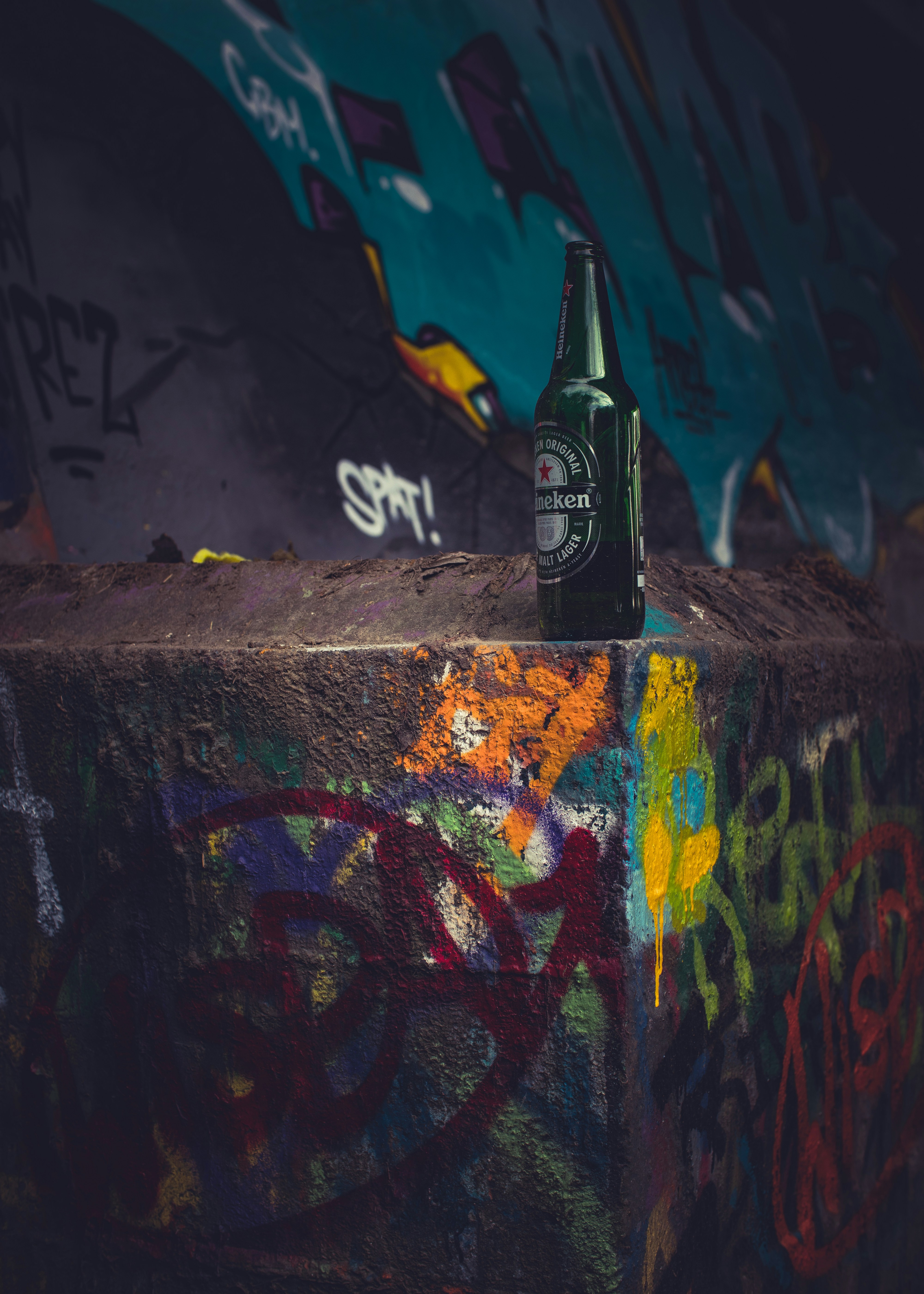 Urban Still Life: Heineken on a Graffitied Concrete Ledge