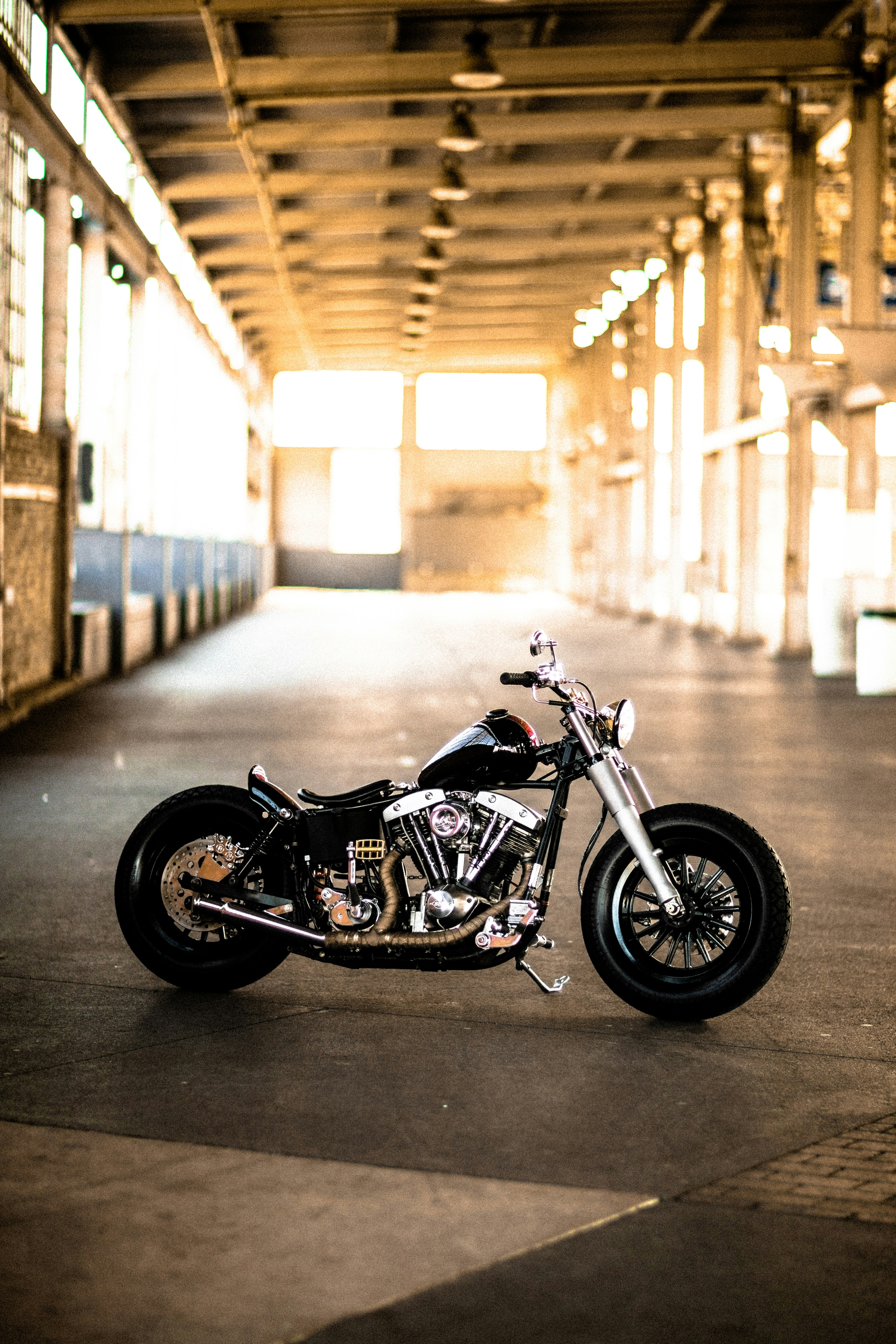 Midnight Chrome: A Rebel Motorcycle in an Echoing Warehouse
