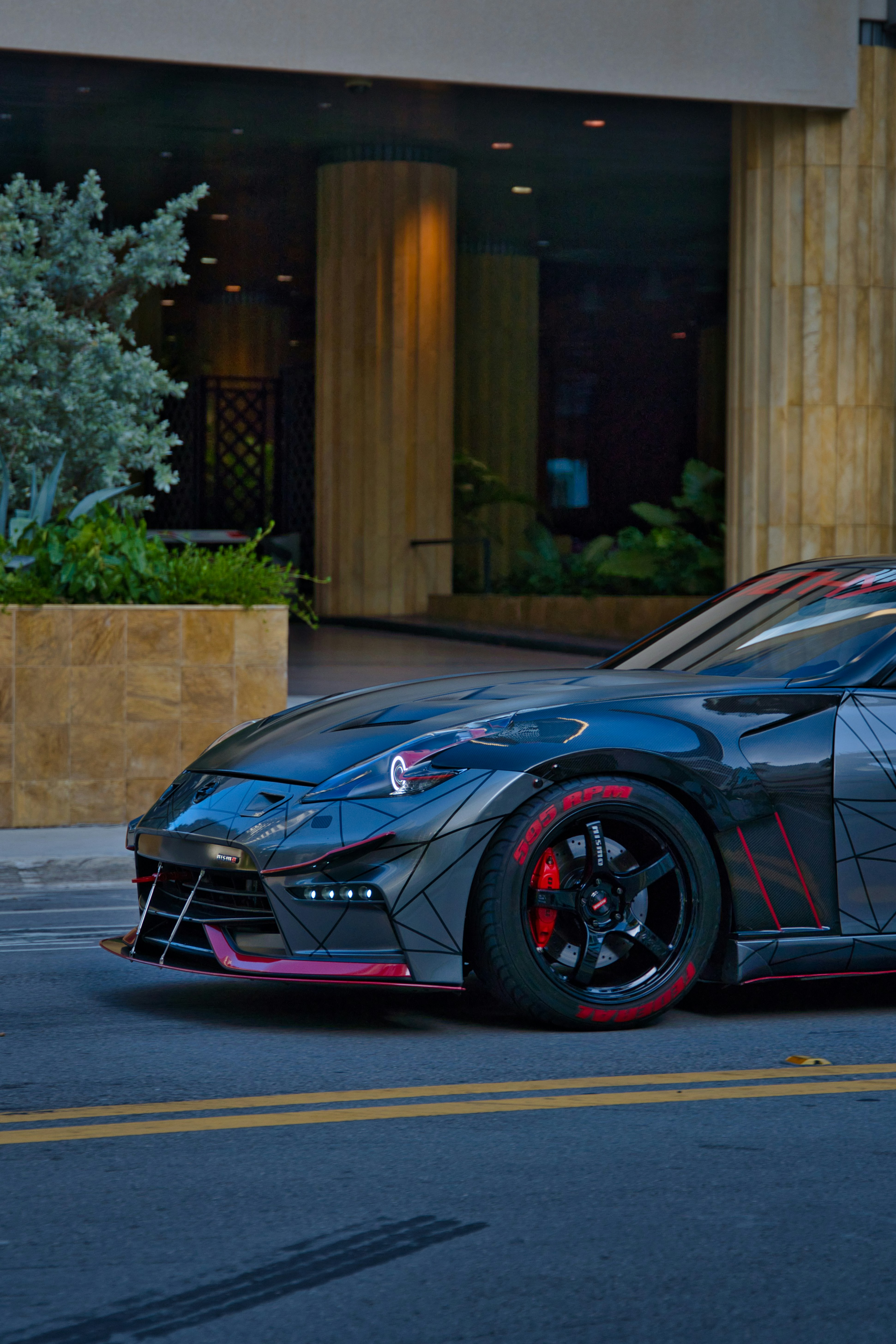 Noir Velocity on the Street: A blue hypercar with red accents under urban lighting