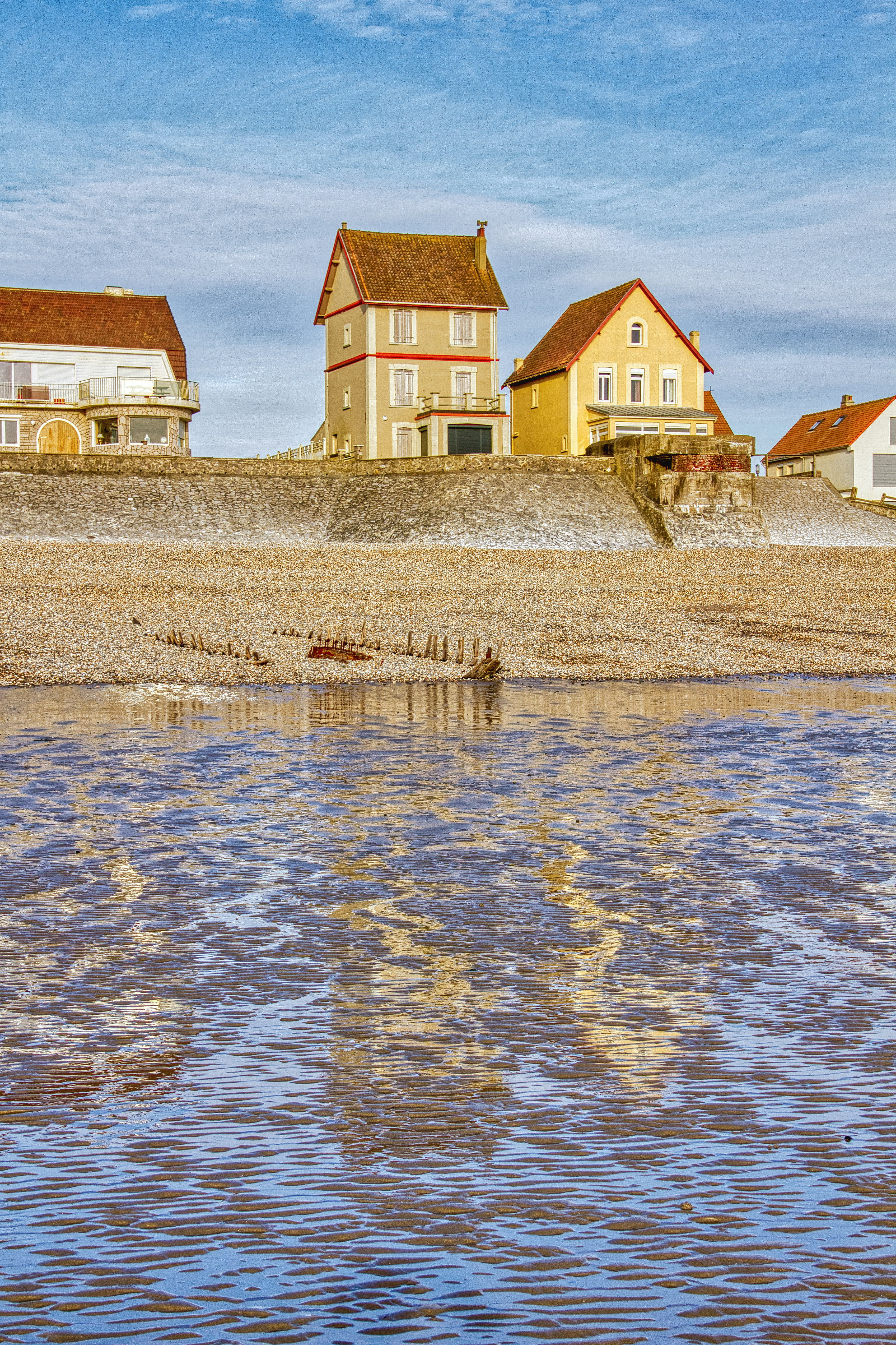 Coastal village trio under a bright seaside sky