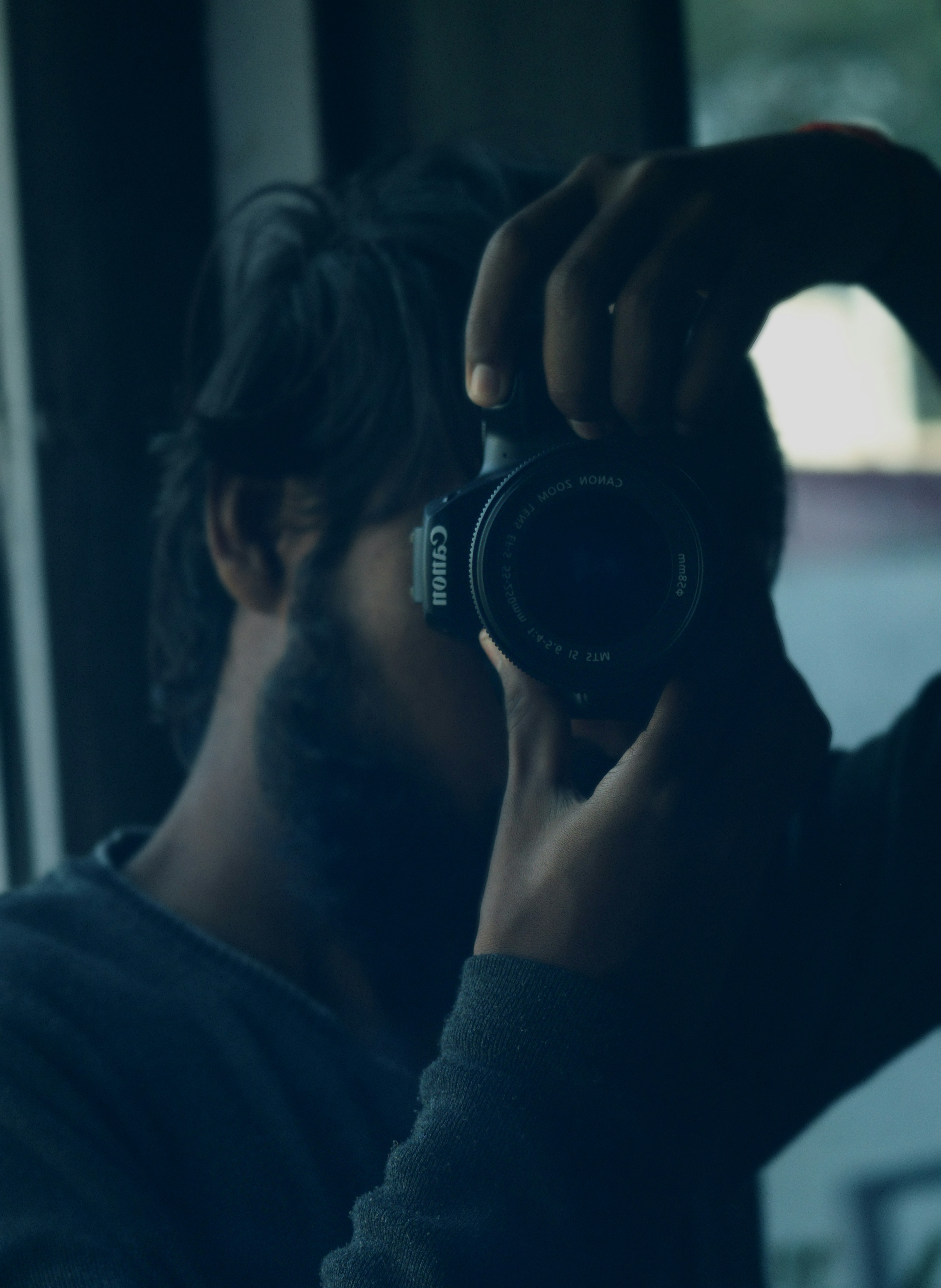 Reflected Focus: A Quiet Portrait Through a Canon Lens