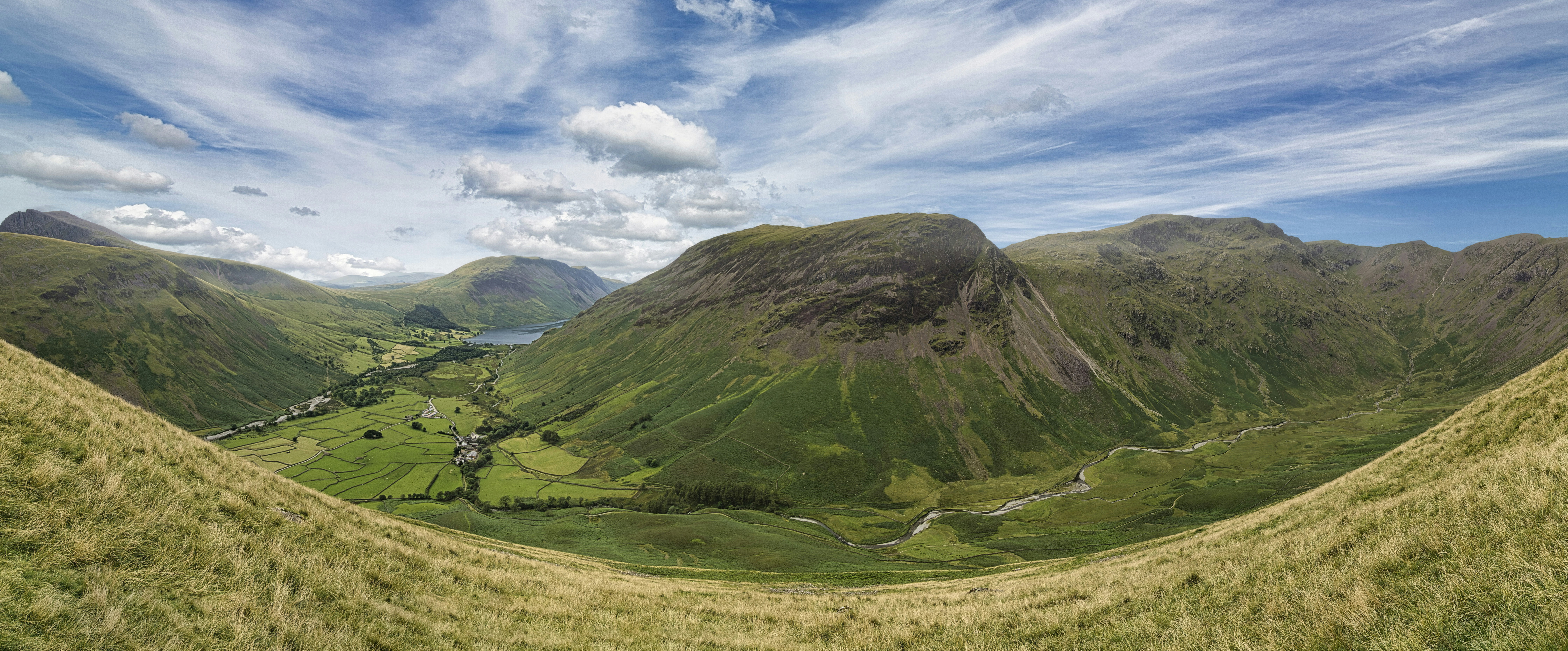 Emerald Valley Panorama Beneath a Sky of Wispy Clouds
