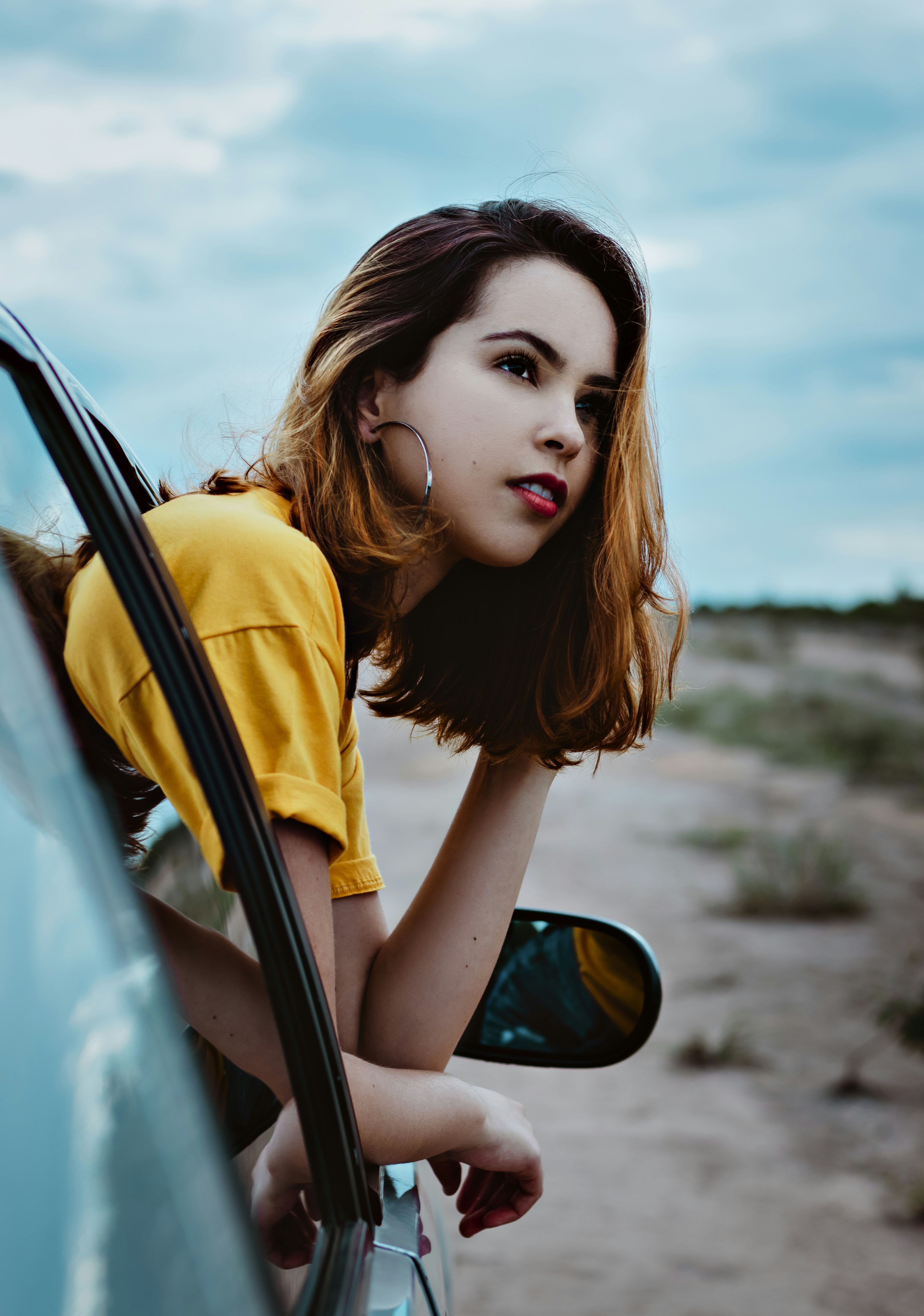 Woman in yellow shirt on blue car photo – Free Girls Image on Unsplash