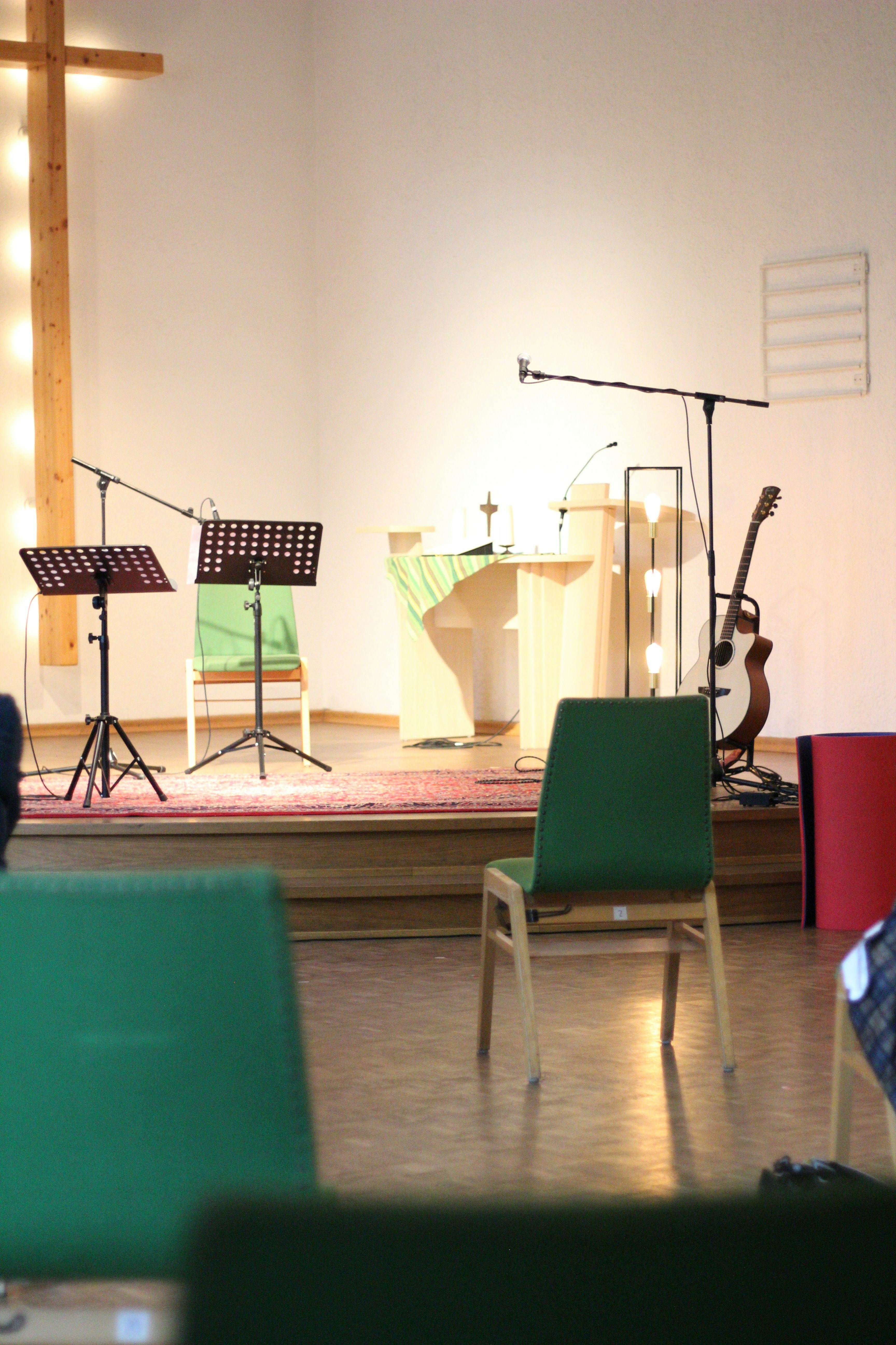Center Stage Quietude: A Minimal Worship Setup with Lectern, Microphones, and Guitar
