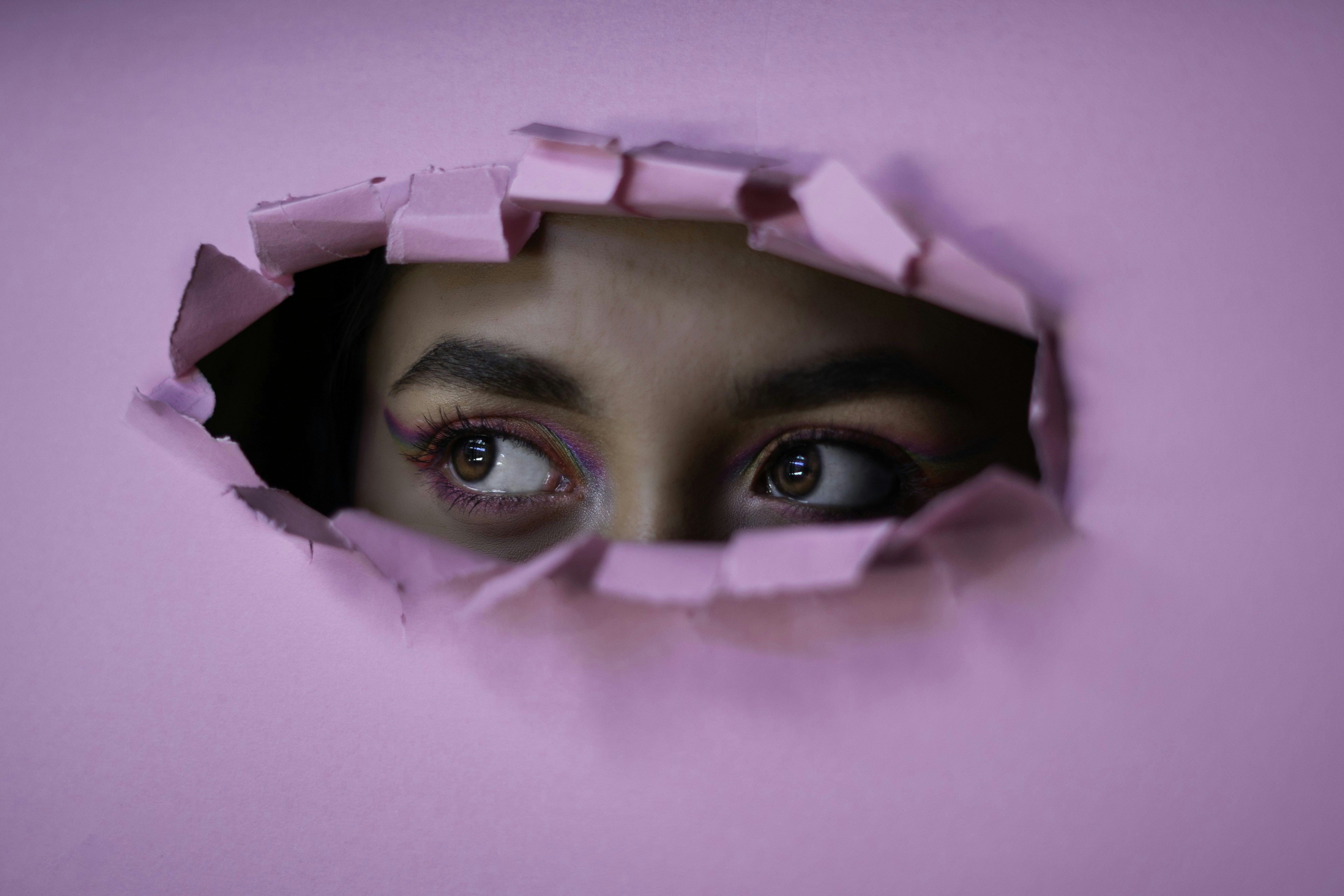 Pink Breakthrough: Eyes through a Shattered Curtain