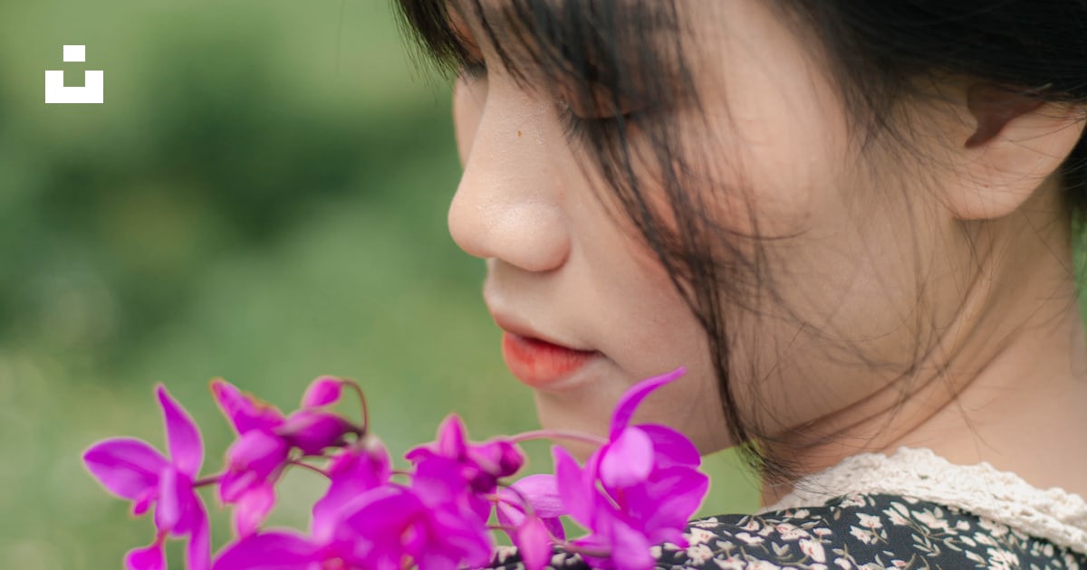 Woman In Black And White Floral Shirt Holding Purple Flower Photo