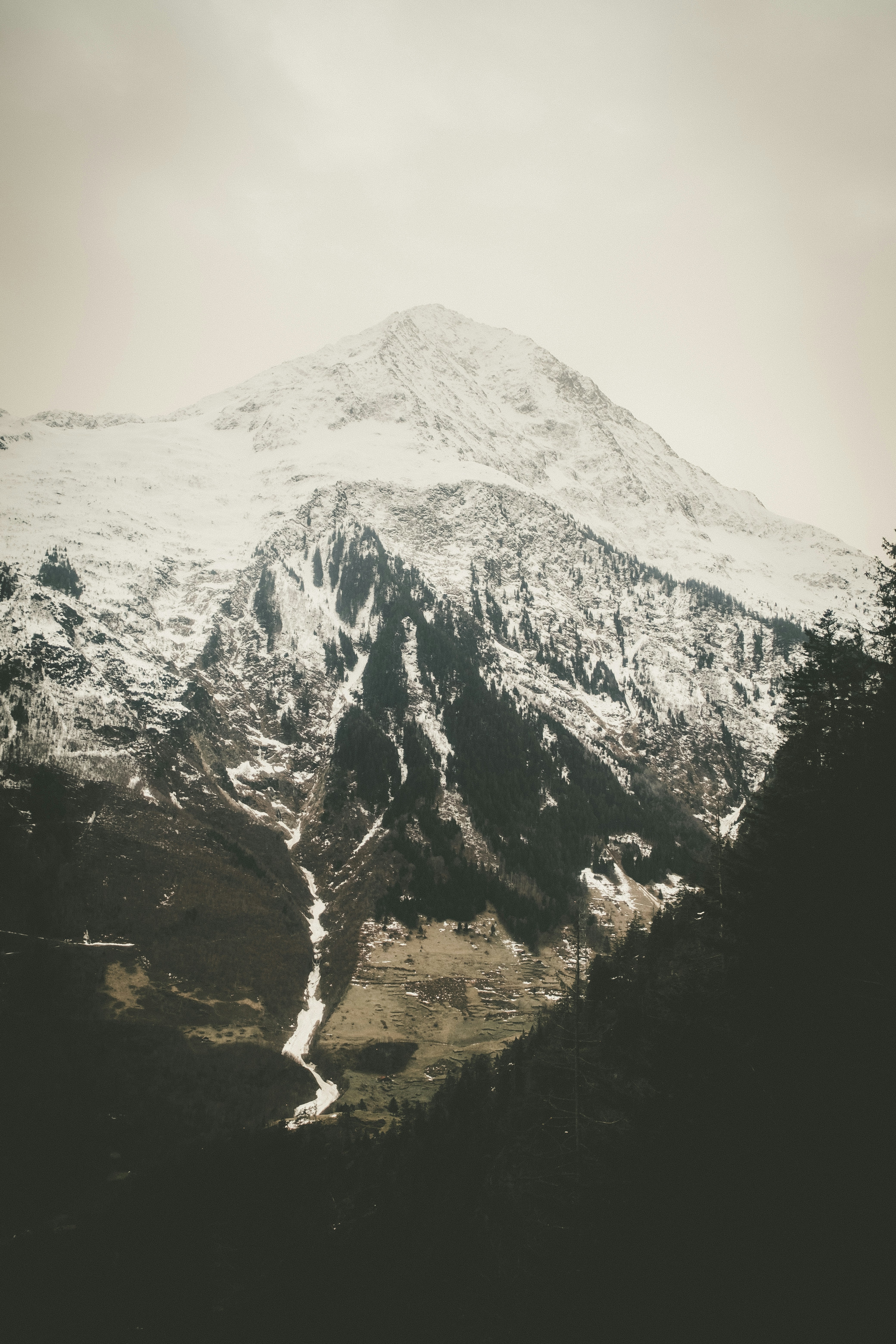 Majestic Alpine Peak Under Overcast Skies