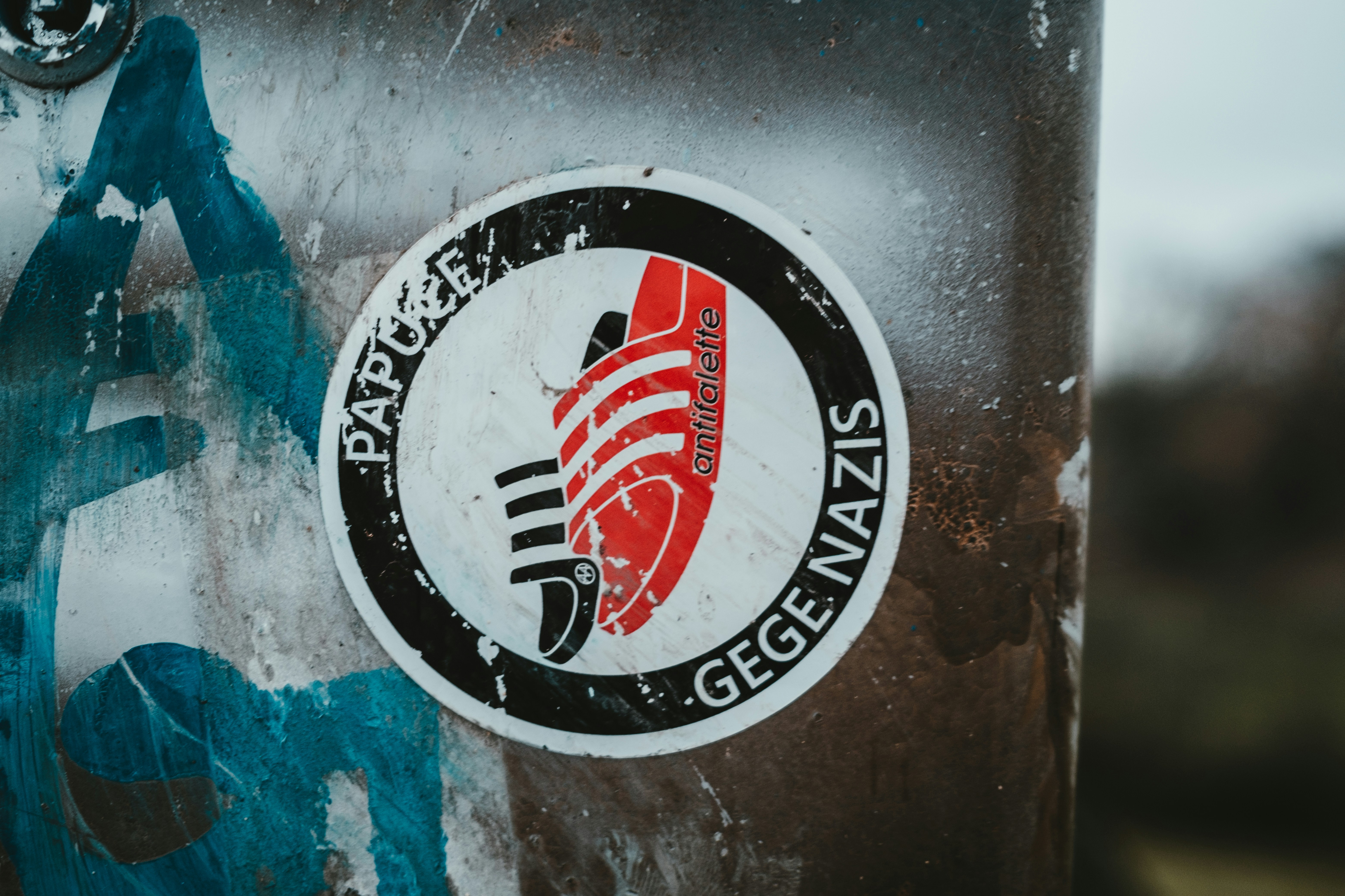 Stickered metal panel with urban grit and peeling paint