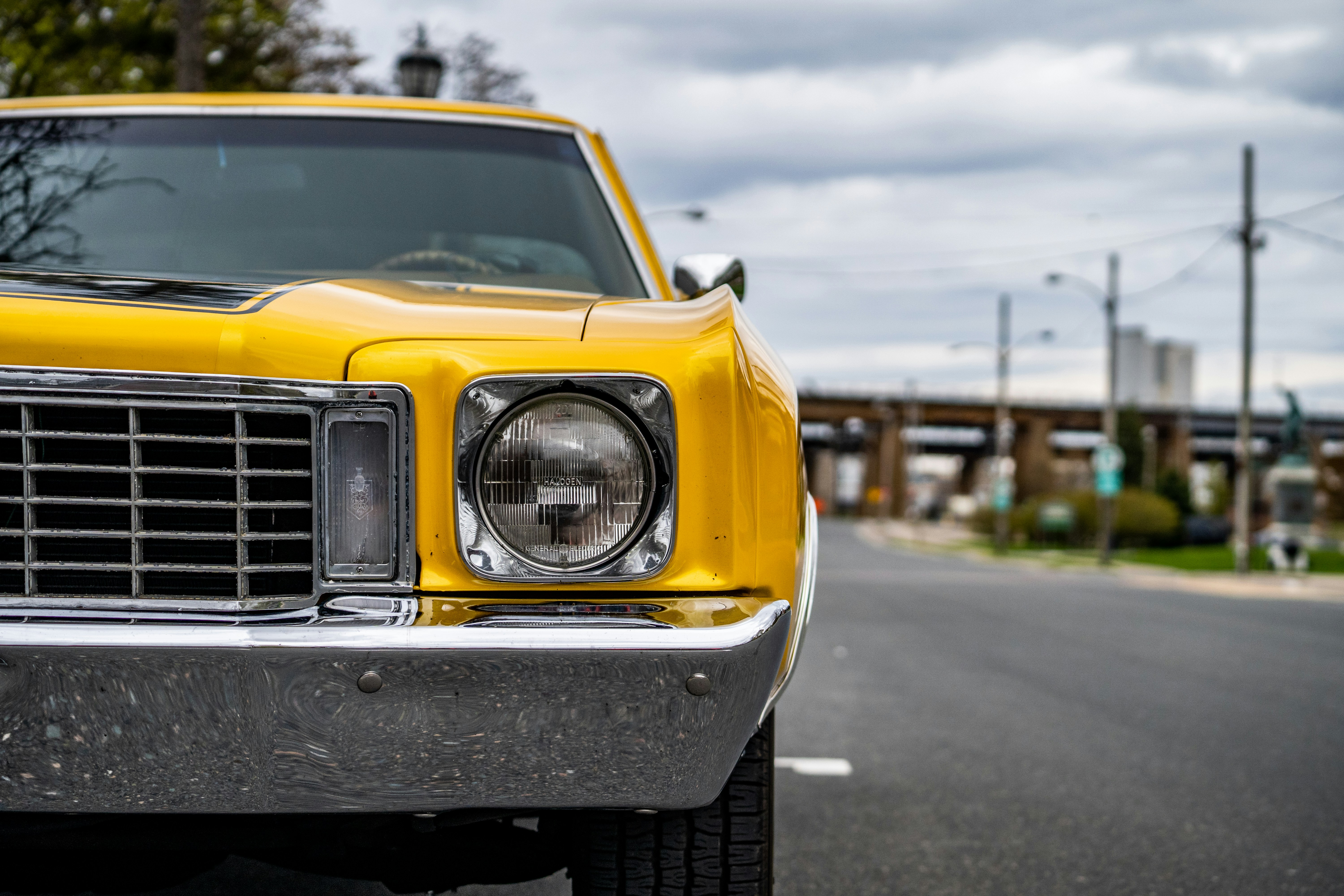 Sunlit Front-Quarter View of a Vintage Yellow Pickup