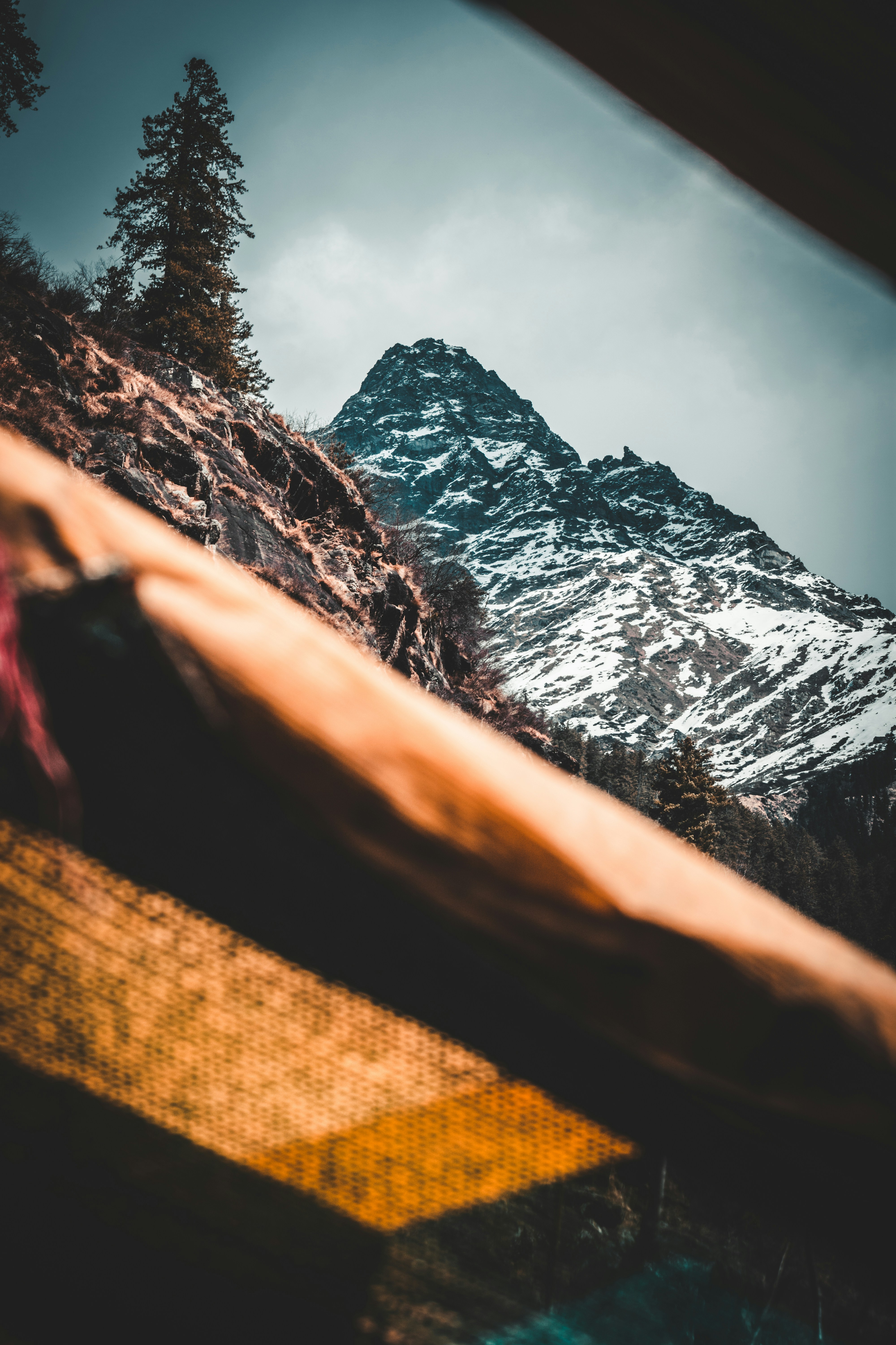 Tilted Roof Framing a Snow-Capped Alpine Peak