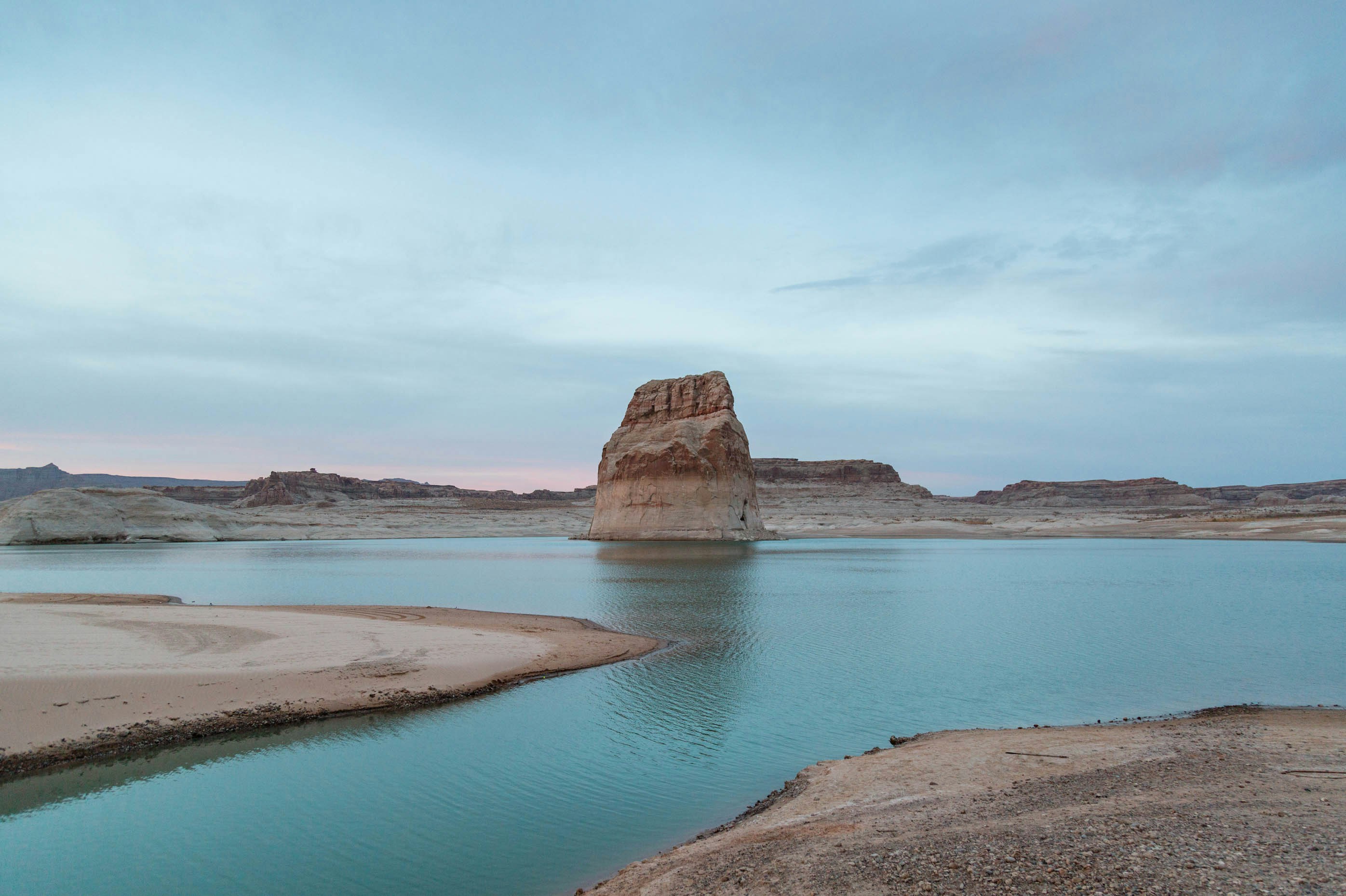 Rimstone Sentinel: A solitary hoodoo rises from turquoise waters