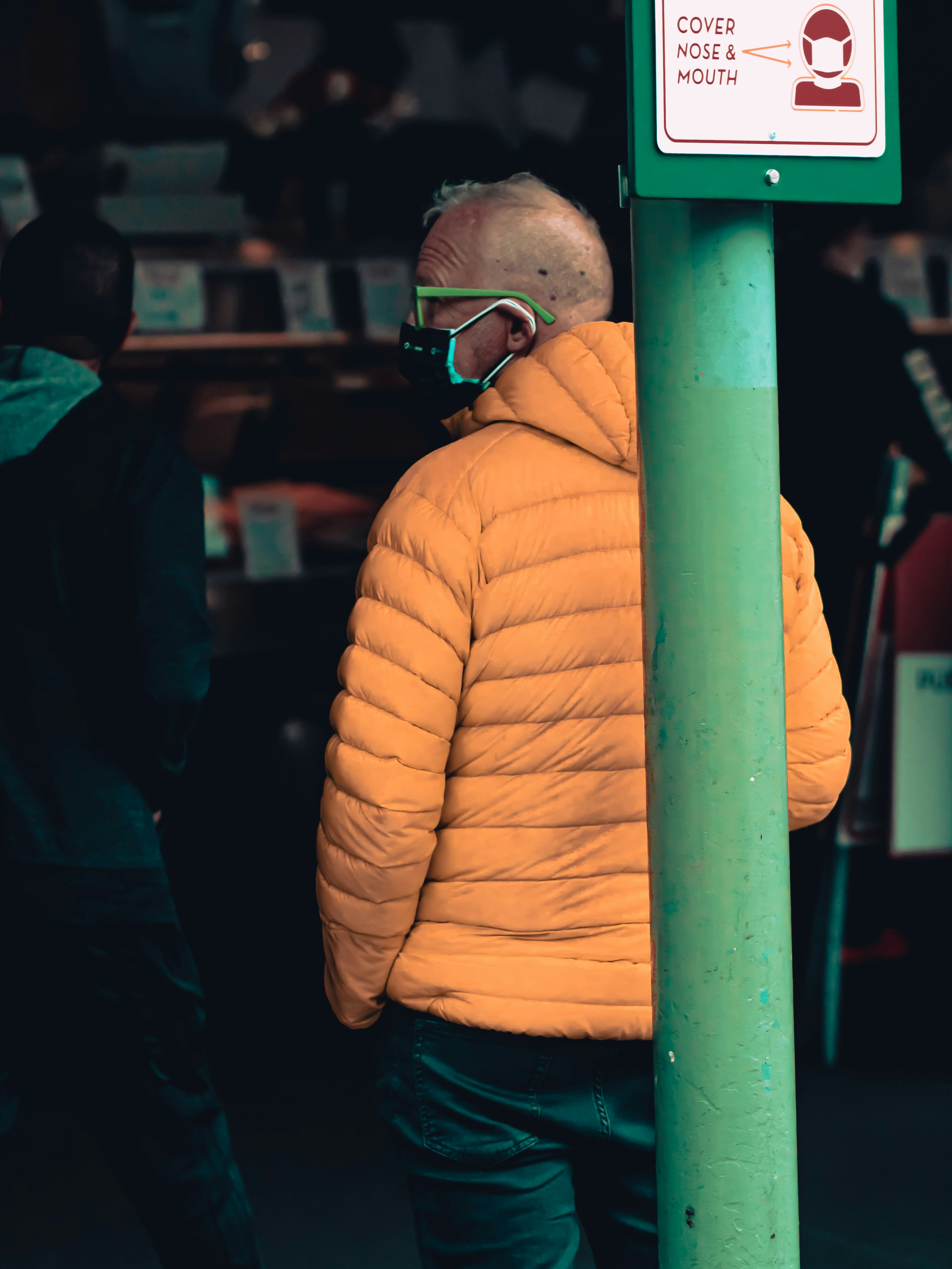 man in orange and black striped long sleeve shirt wearing black goggles