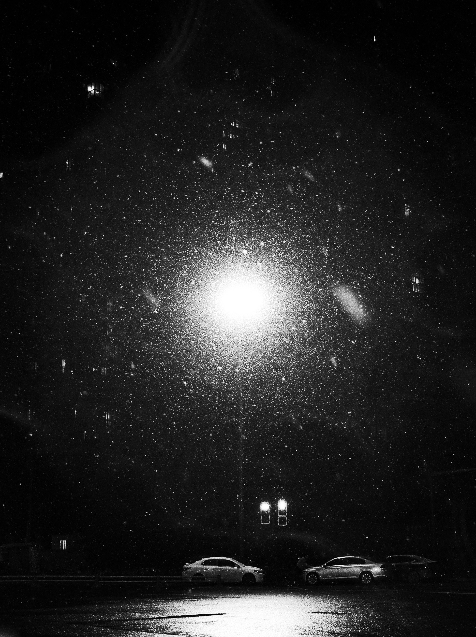 Midnight Beacon Over a Rain-Slick Parking Lot
