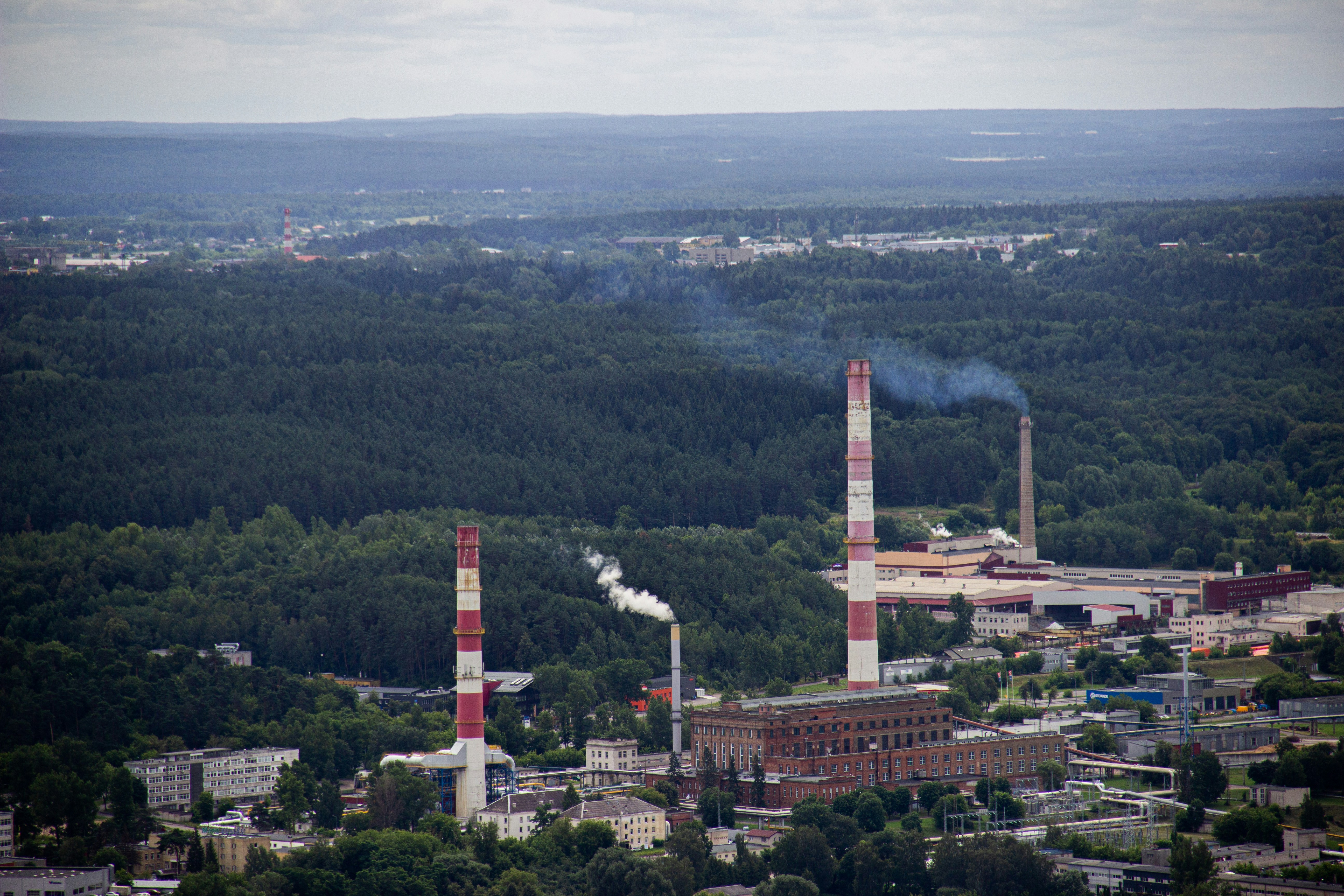 Industrial Silhouettes Against Verdant Horizons