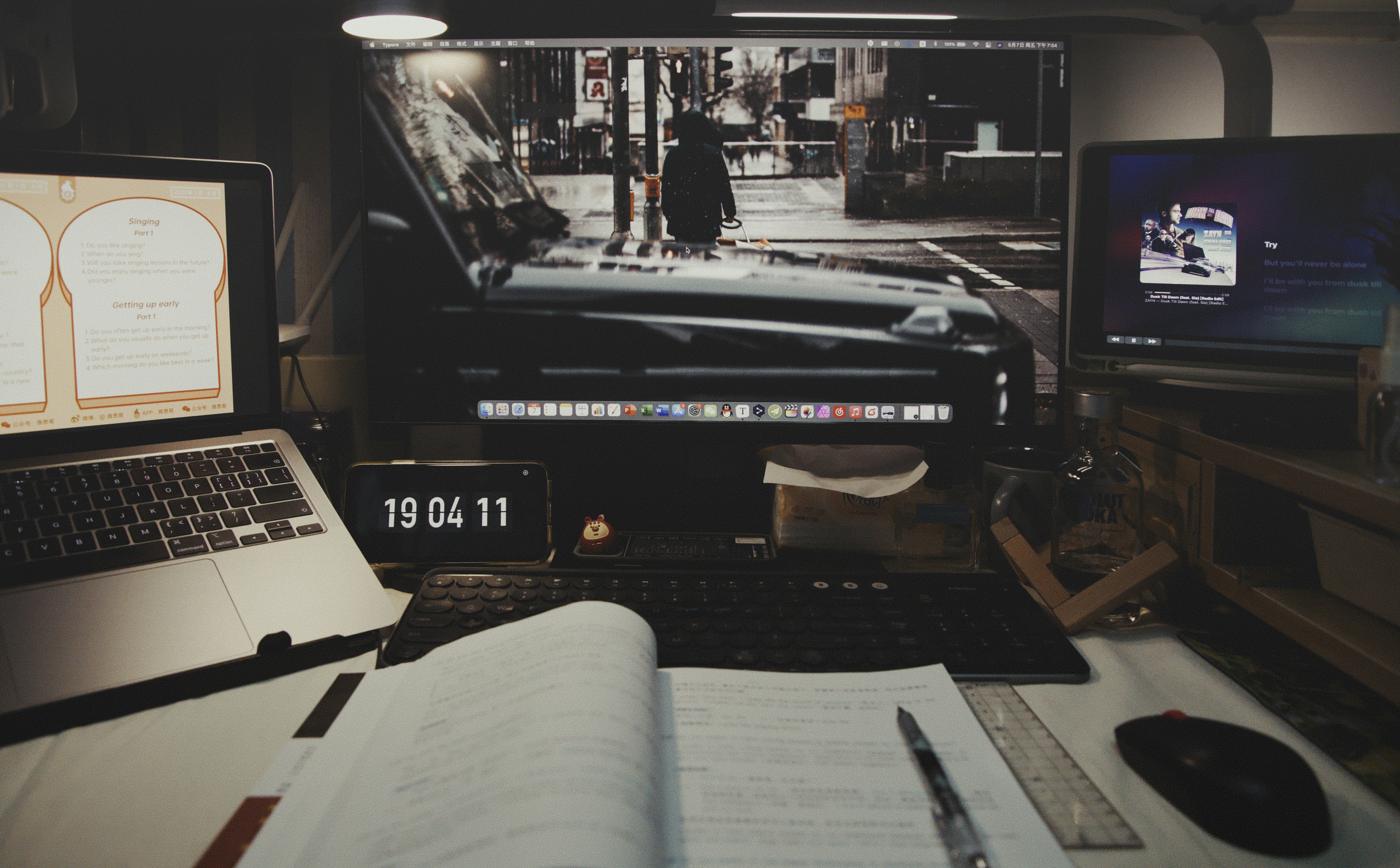 A laptop computer sitting on top of a desk next to a monitor photo ...