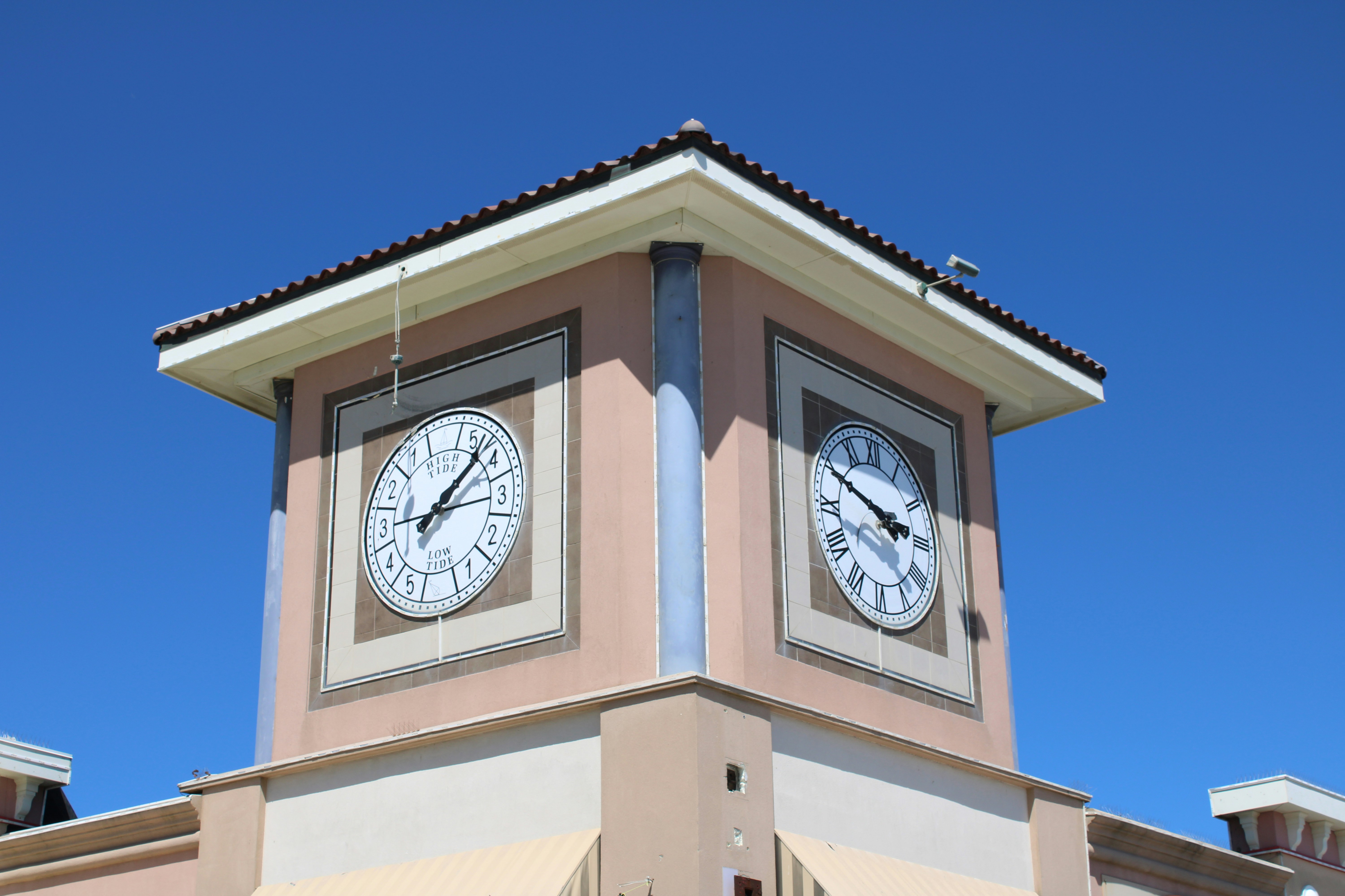 beige concrete building with analog clock