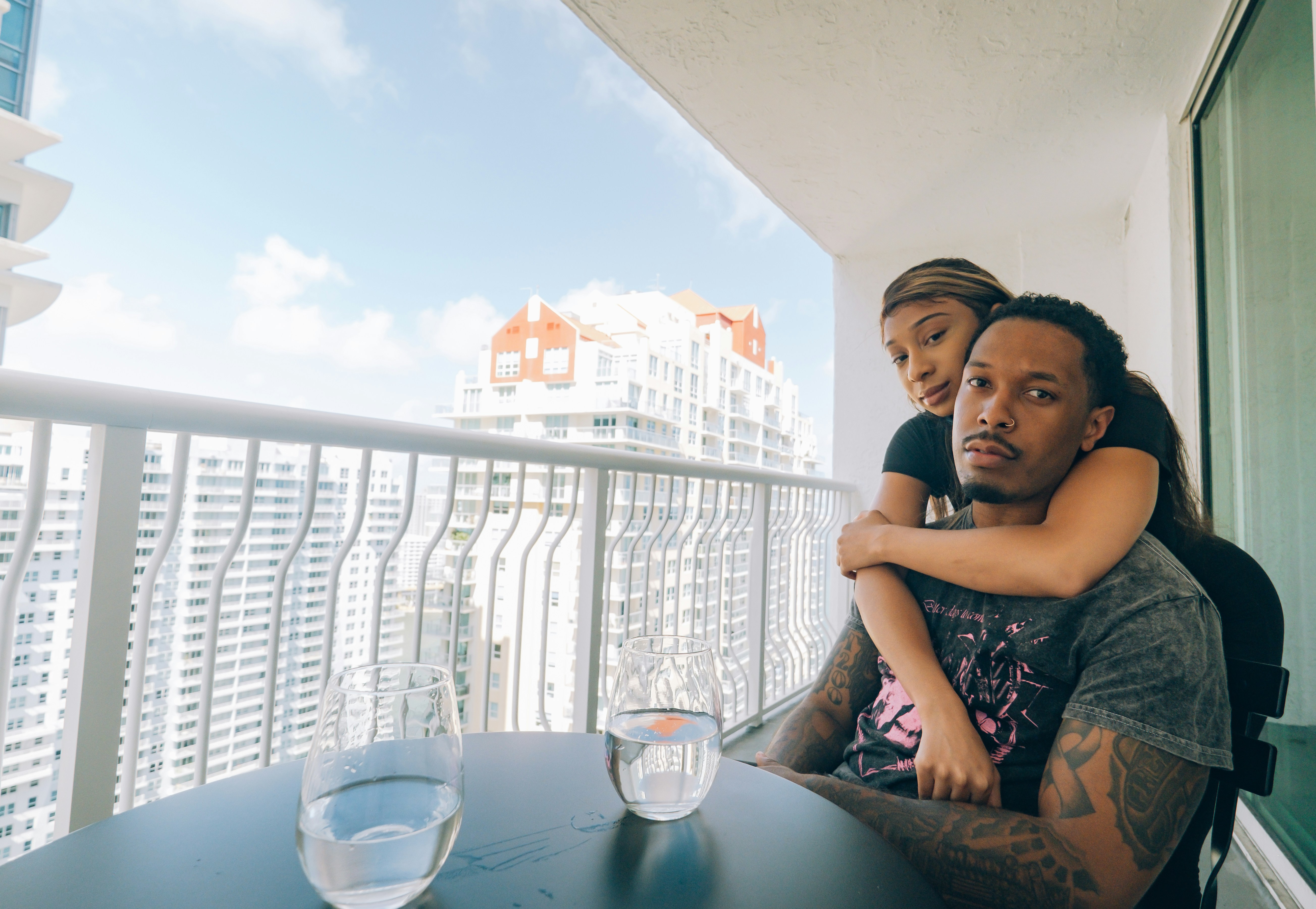 Balcony Portrait: Close Bond Against a Cityscape