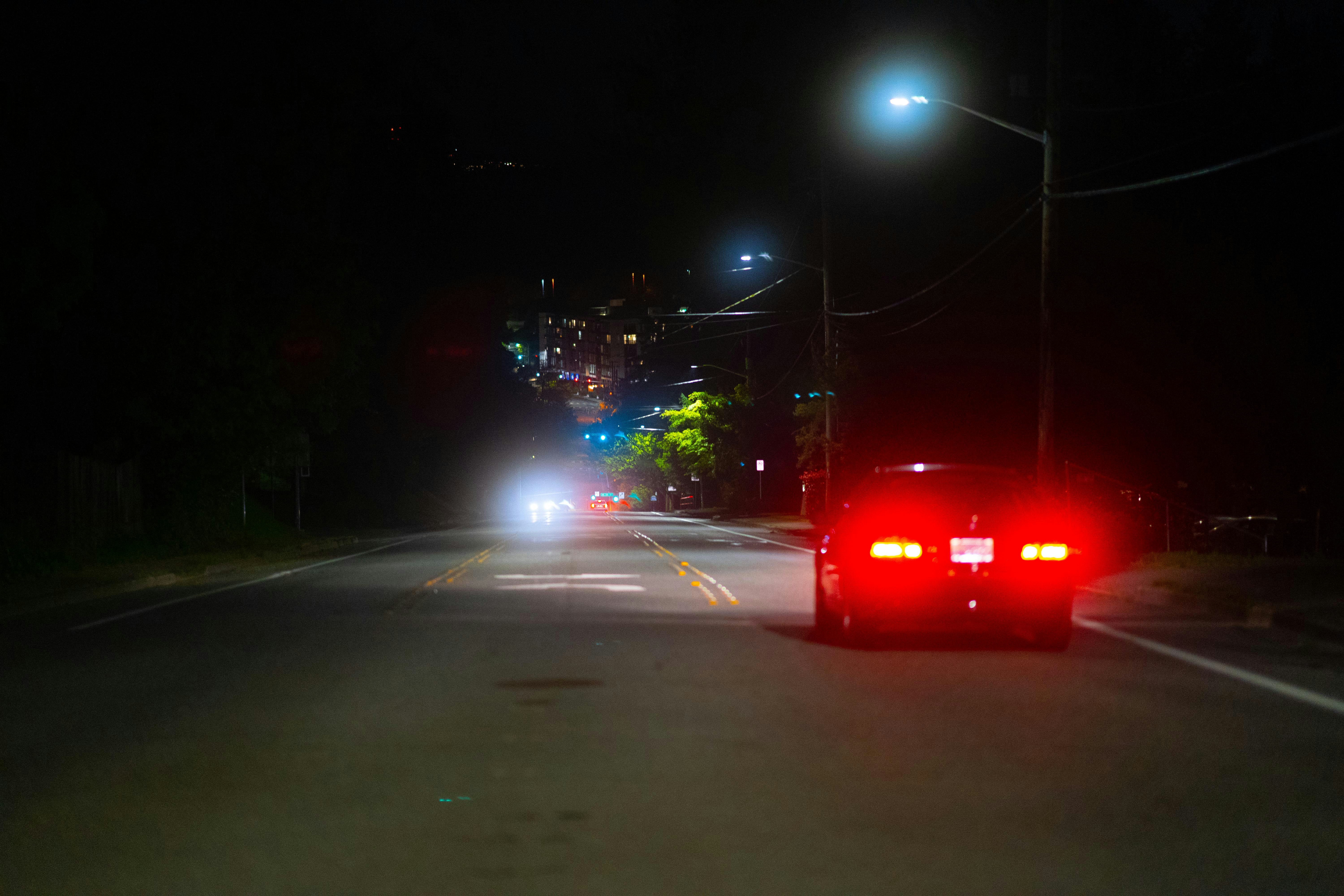 Car Driving Away At Night