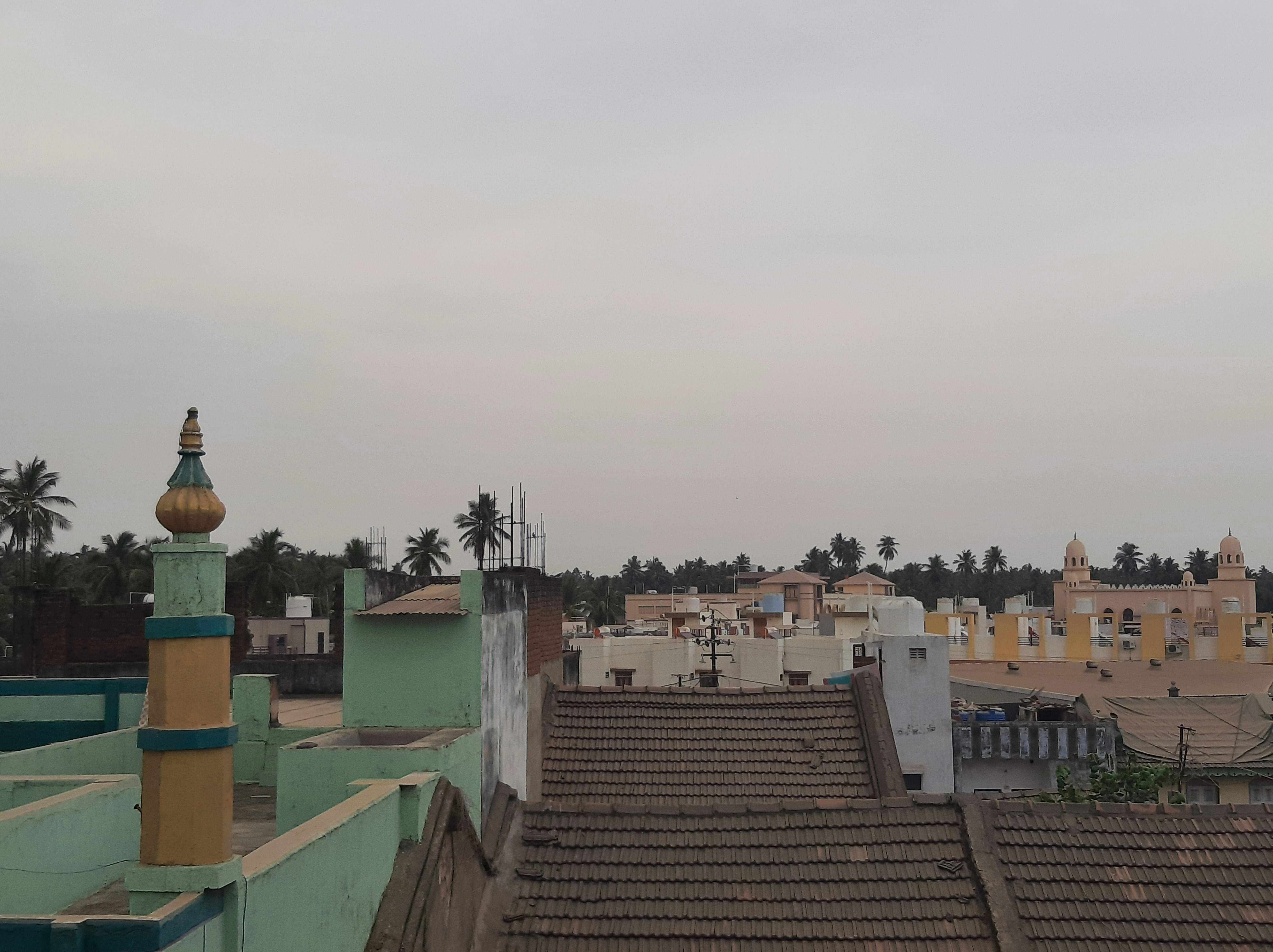 Turquoise Minaret Among Pastel Rooftops
