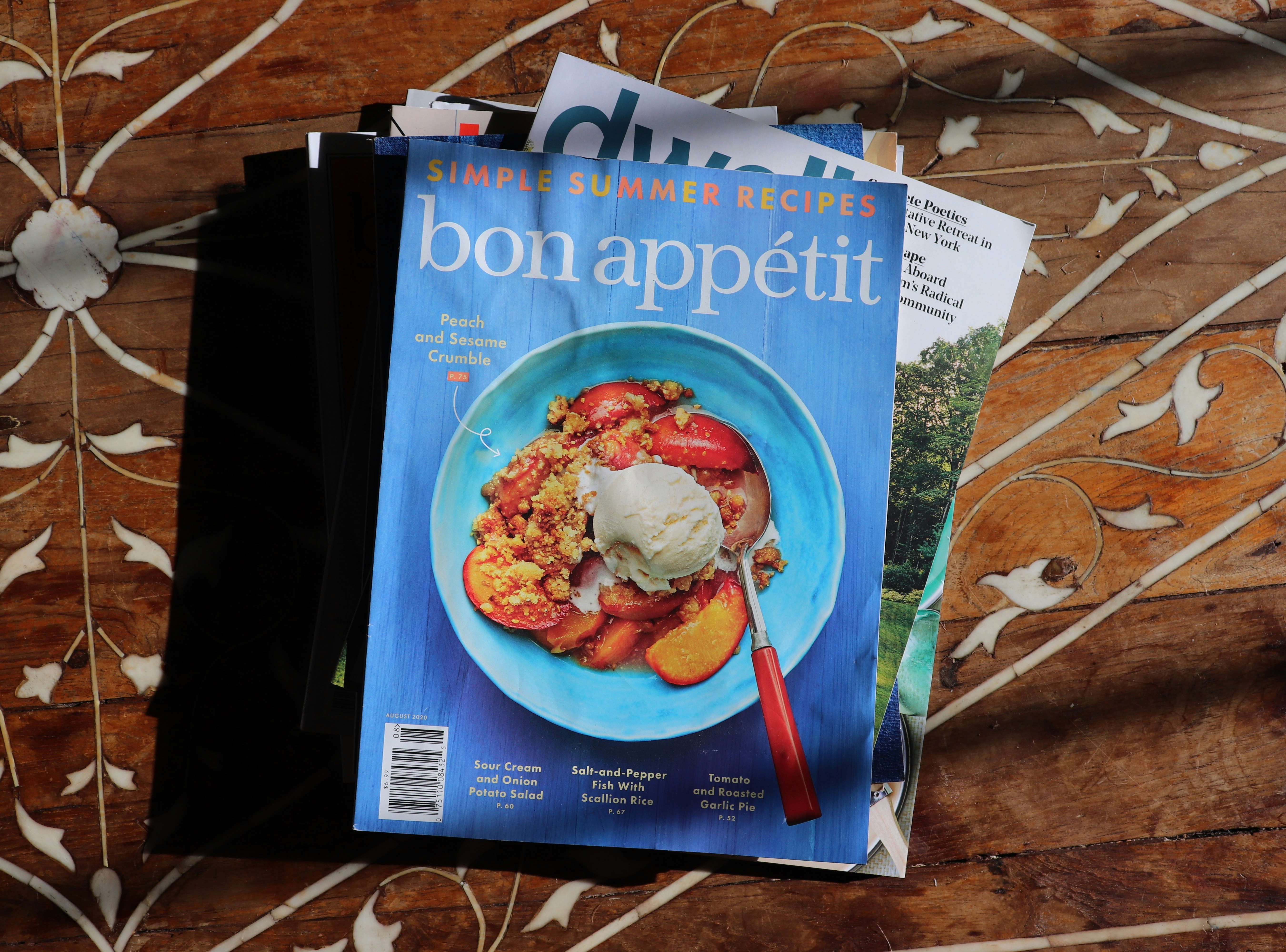 A magazine sitting on top of a wooden table photo – Free Orlando Image ...
