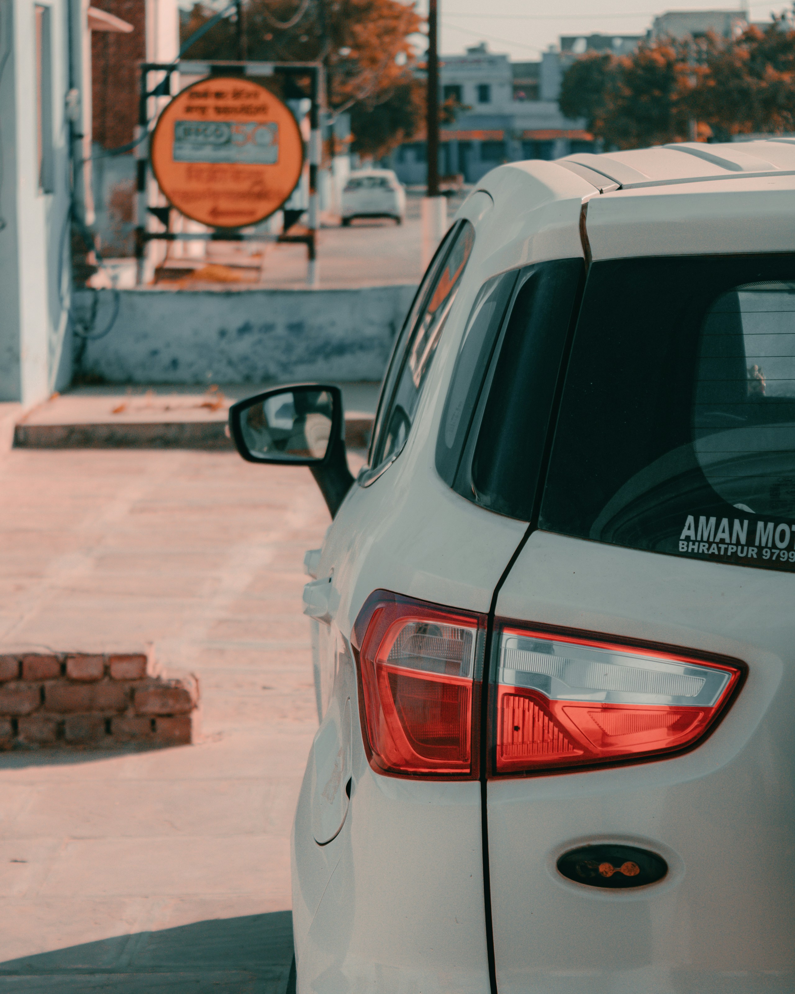 Rear-View Resolve: A White SUV on a Sun-Warmed City Street