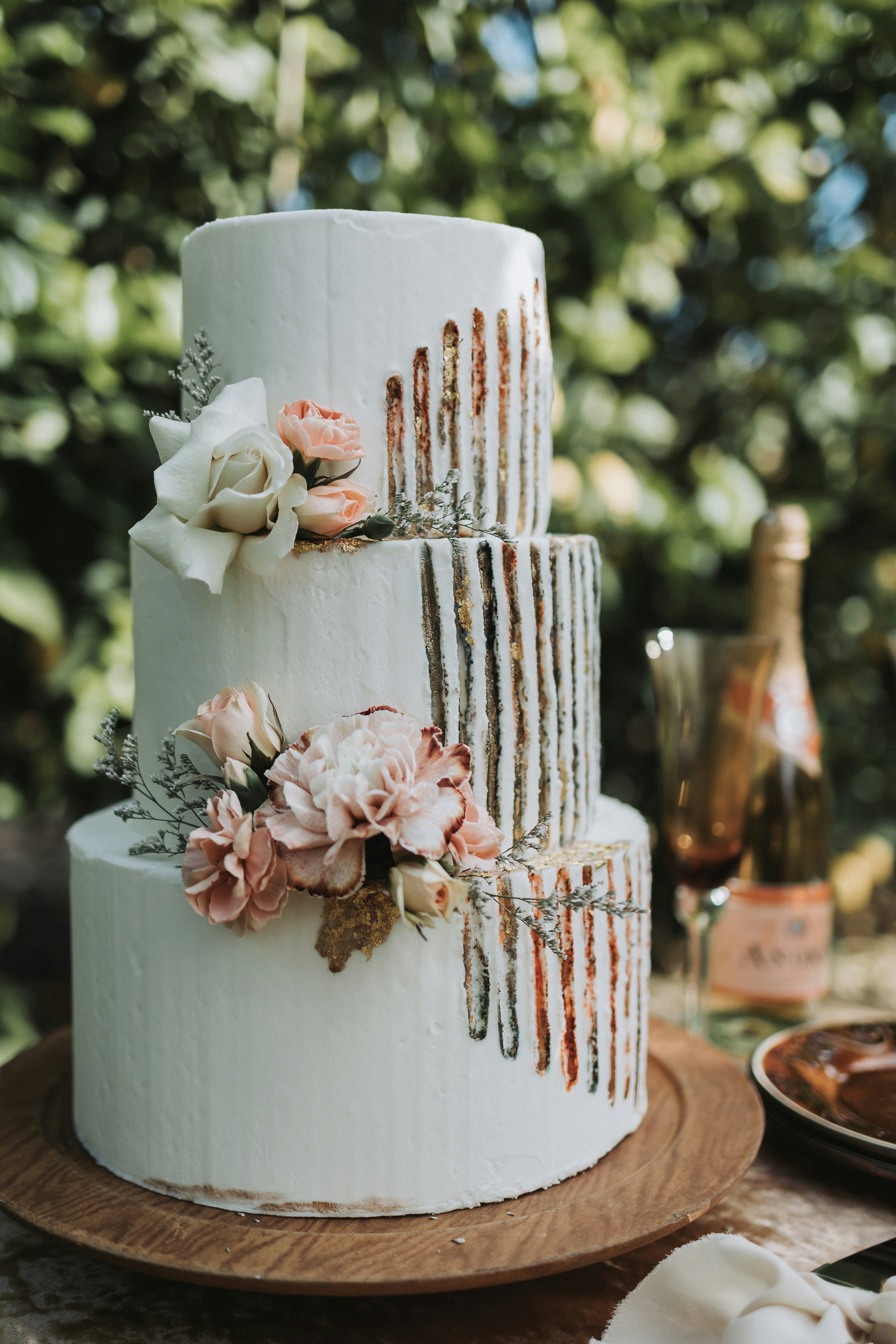 Here is a caption for the image: elegant three-tiered cake decorated ...