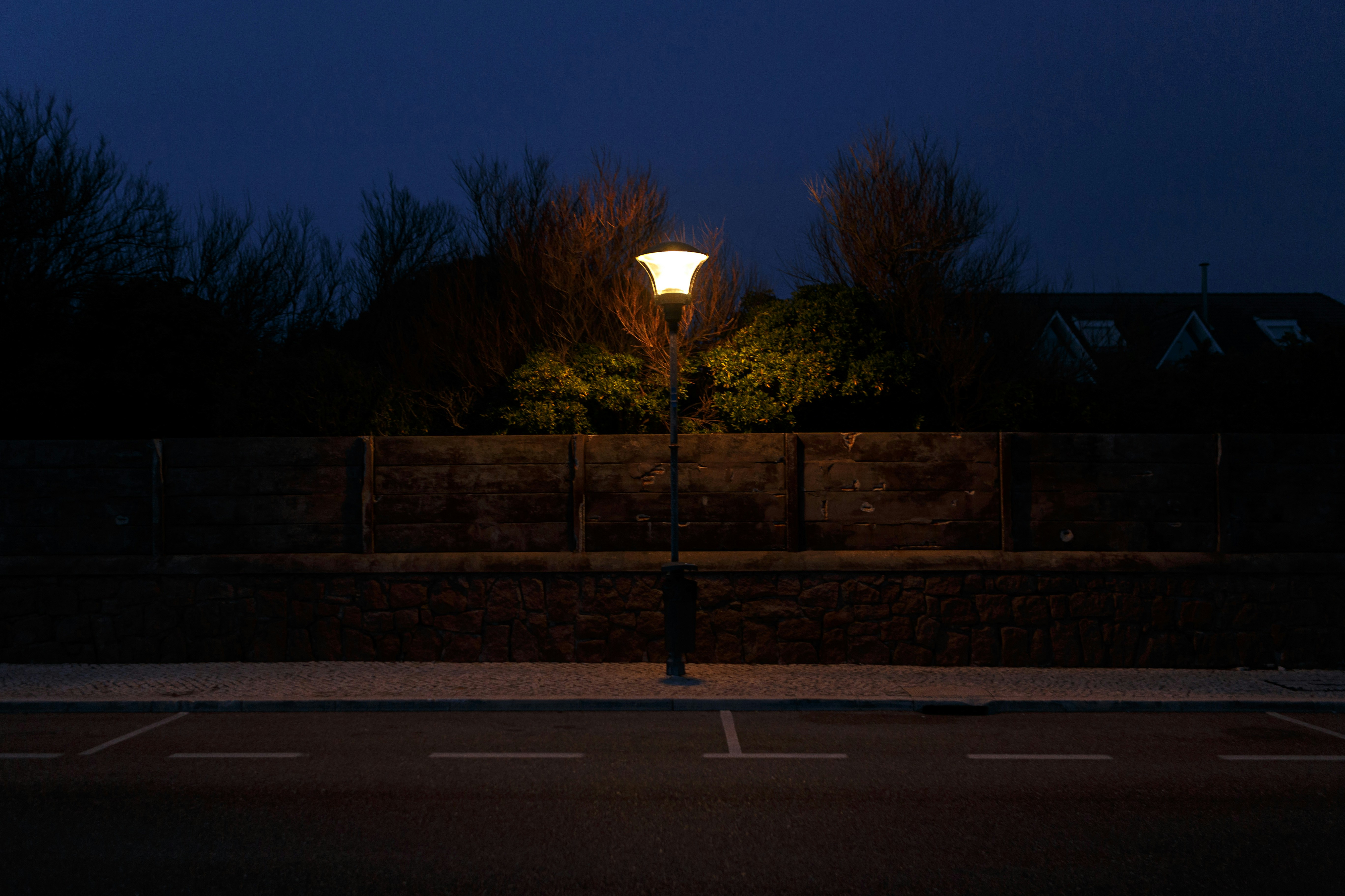 White light post near brown wooden fence during night time photo – Free ...